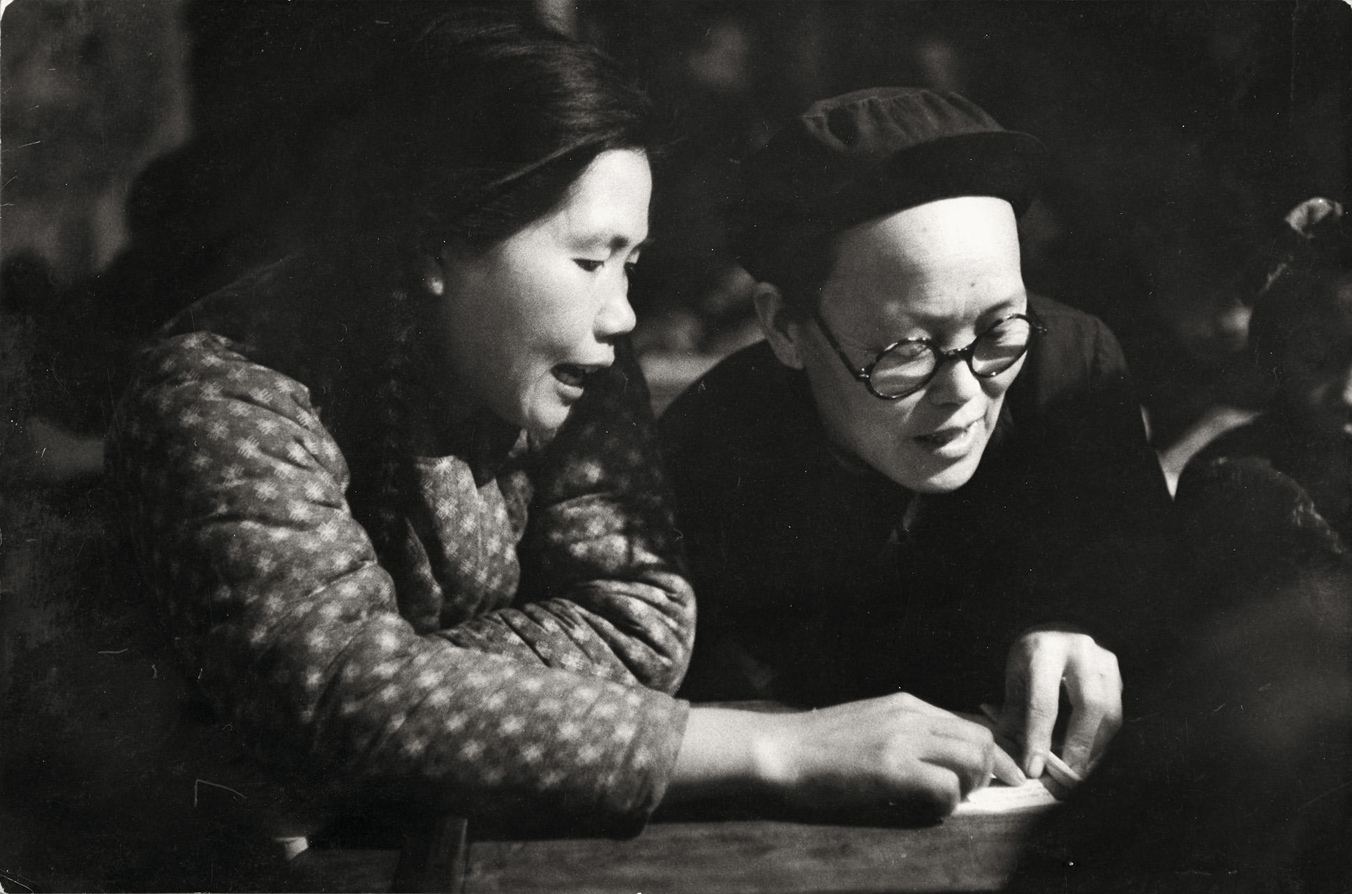 Marc Riboud | Two women reading (1957) | MutualArt