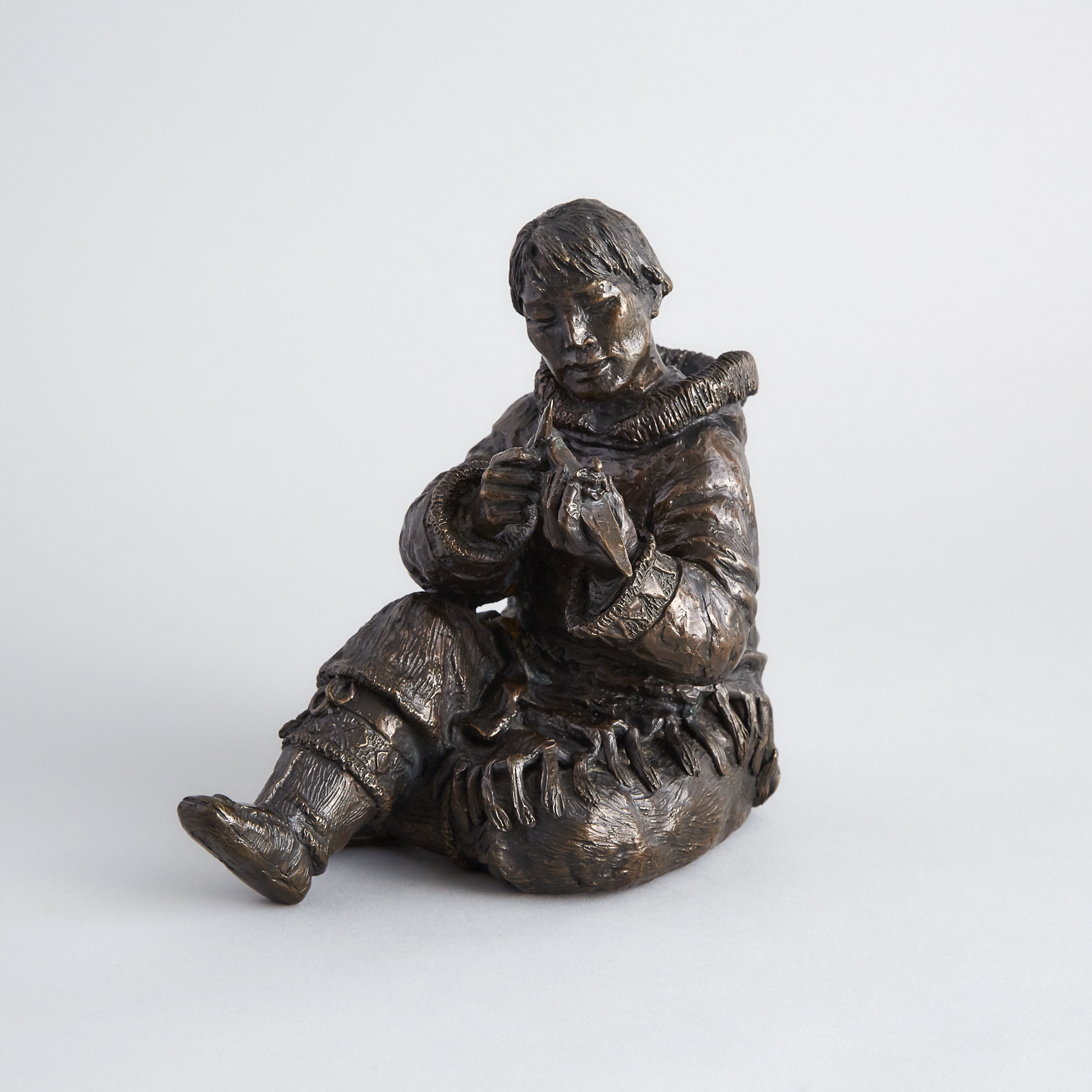 Nori Peter | INUIT ARTIST CARVING A MODEL OF A KAYAK | MutualArt