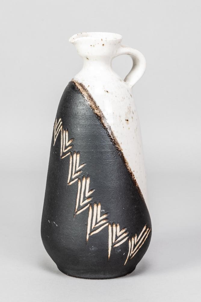 Barbara Cass | a stoneware bottle with side handle partially covered in ...