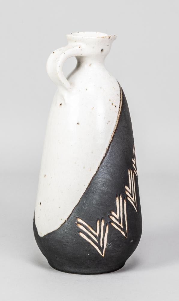 Barbara Cass | a stoneware bottle with side handle partially covered in ...