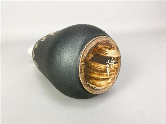 Barbara Cass | a stoneware bottle with side handle partially covered in ...