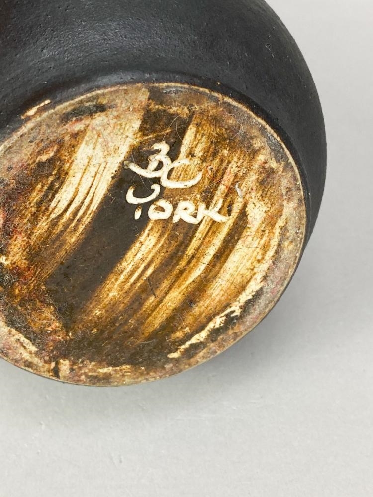 Barbara Cass | a stoneware bottle with side handle partially covered in ...