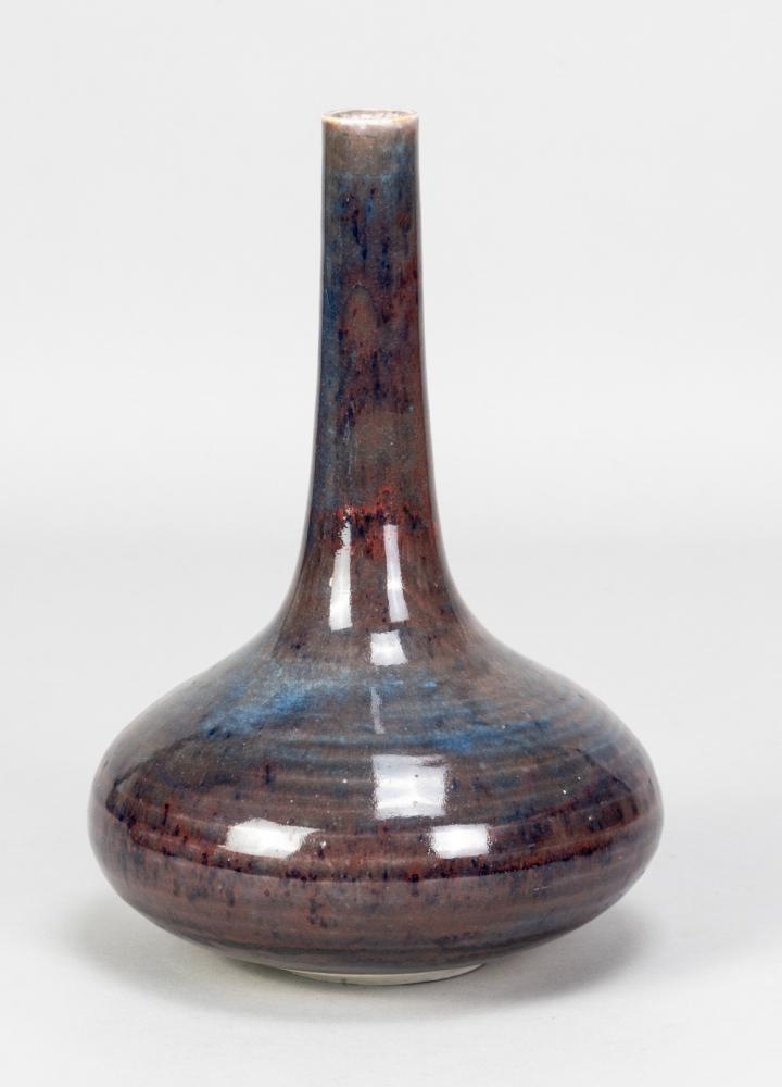 Derek Davis | a large porcelain bottle with narrow neck covered in ...