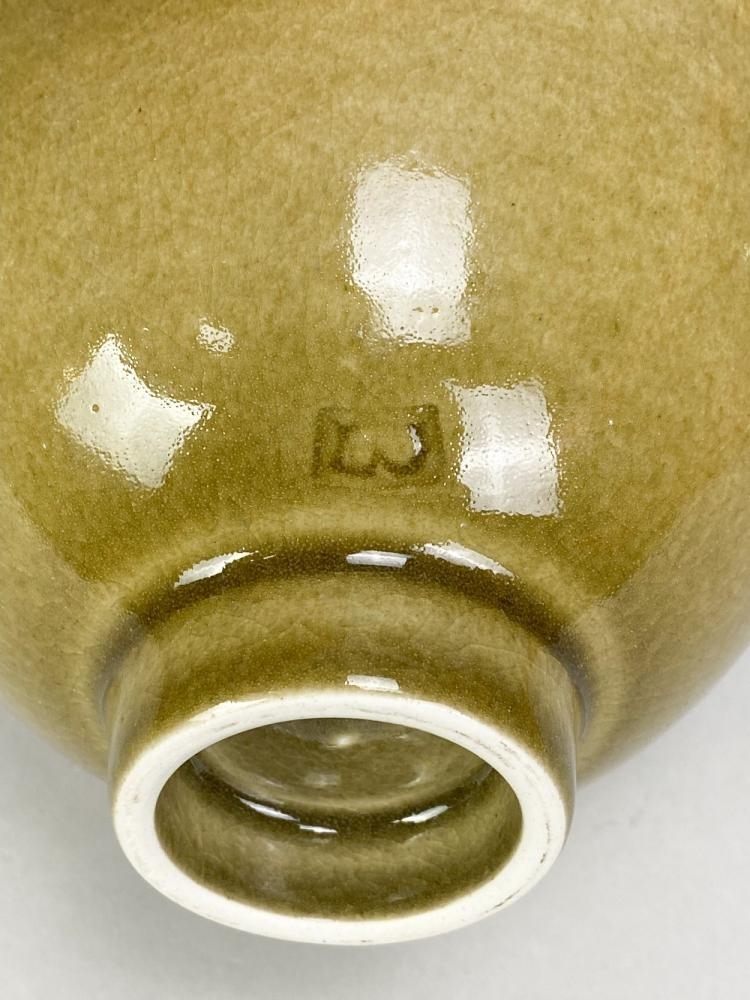 David Lloyd Jones | a porcelain footed bowl covered in green glaze with ...