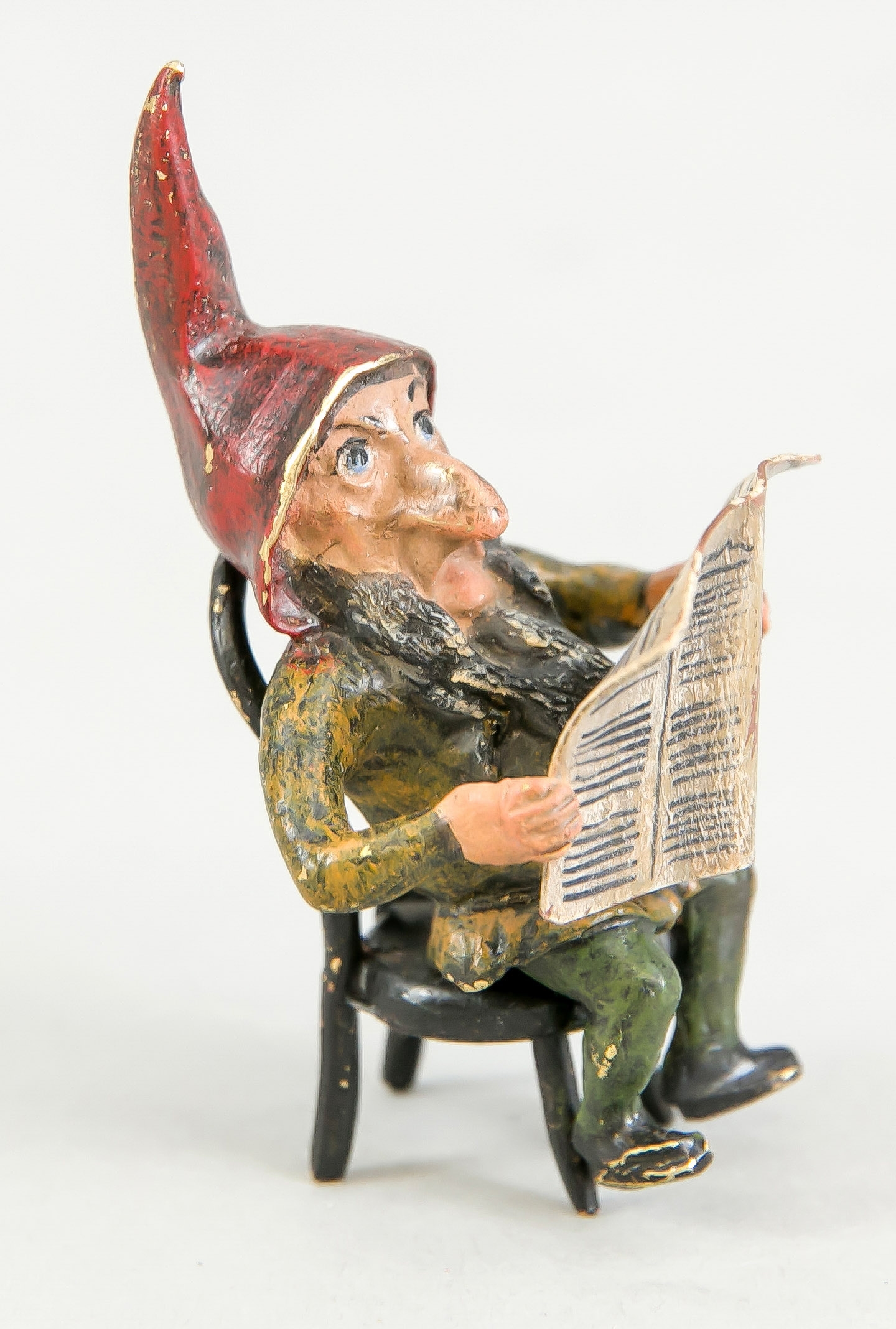 Vienna School, 20th Century | Dwarf sitting on a chair reading a ...