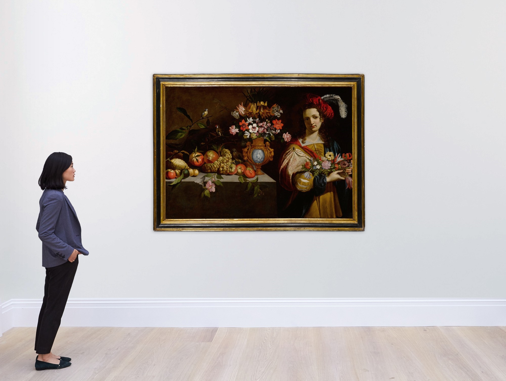 Giovanni Stanchi | Still life with fruits, a vase, birds and a youth ...