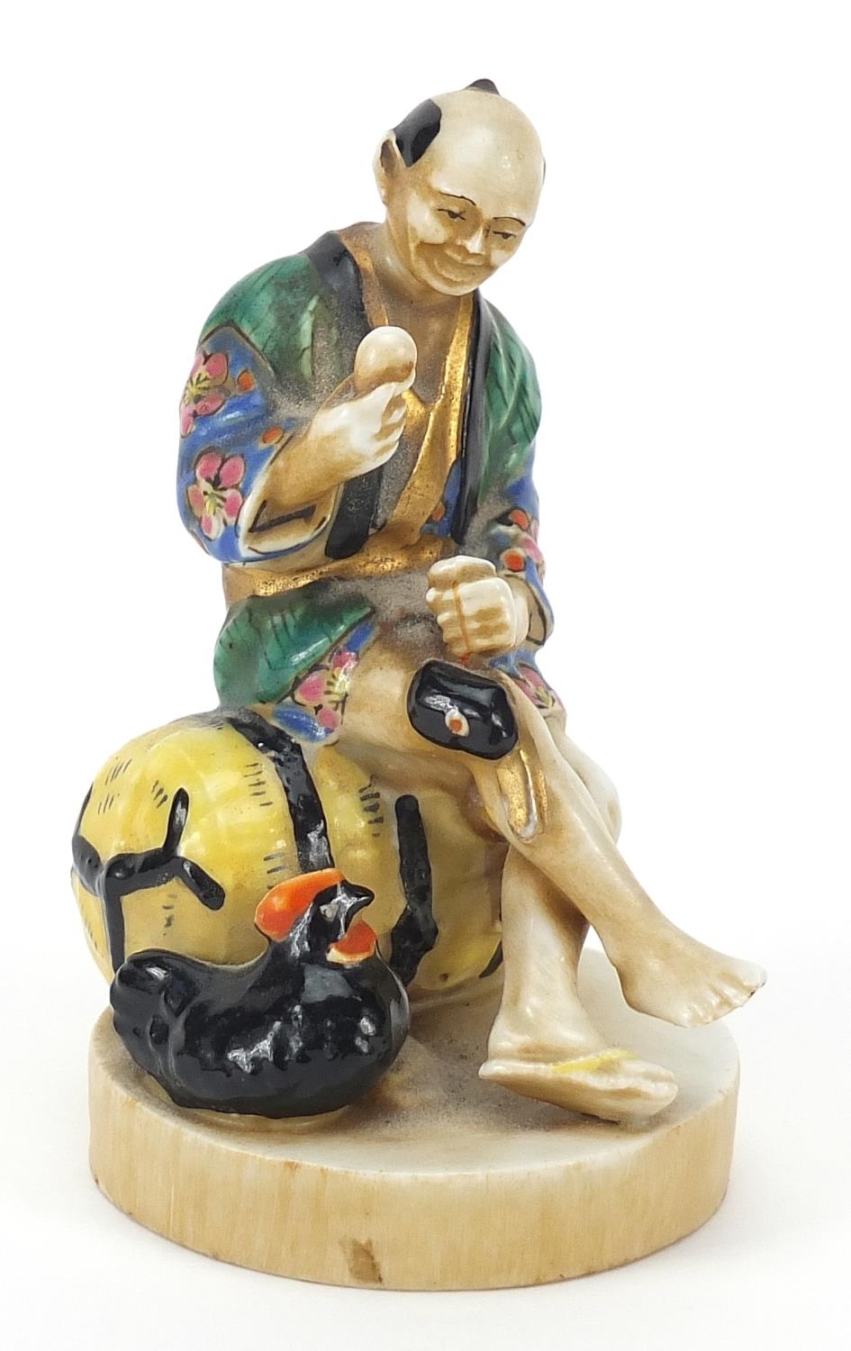 Japanese School | Japanese porcelain figure of a seated gentleman with ...