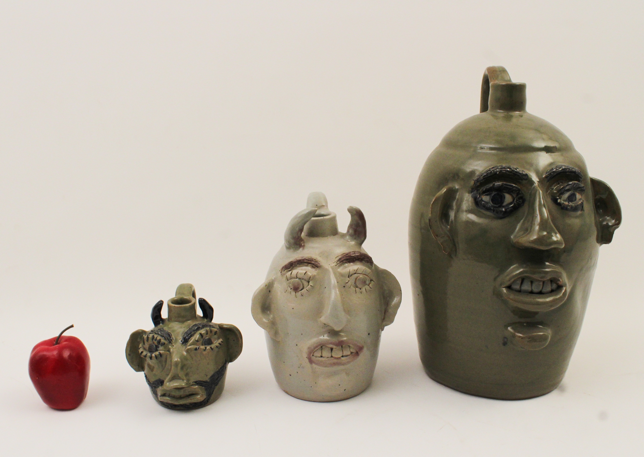 Jerry Brown | Group of three folk art pottery jugs by Jerry Brown ...