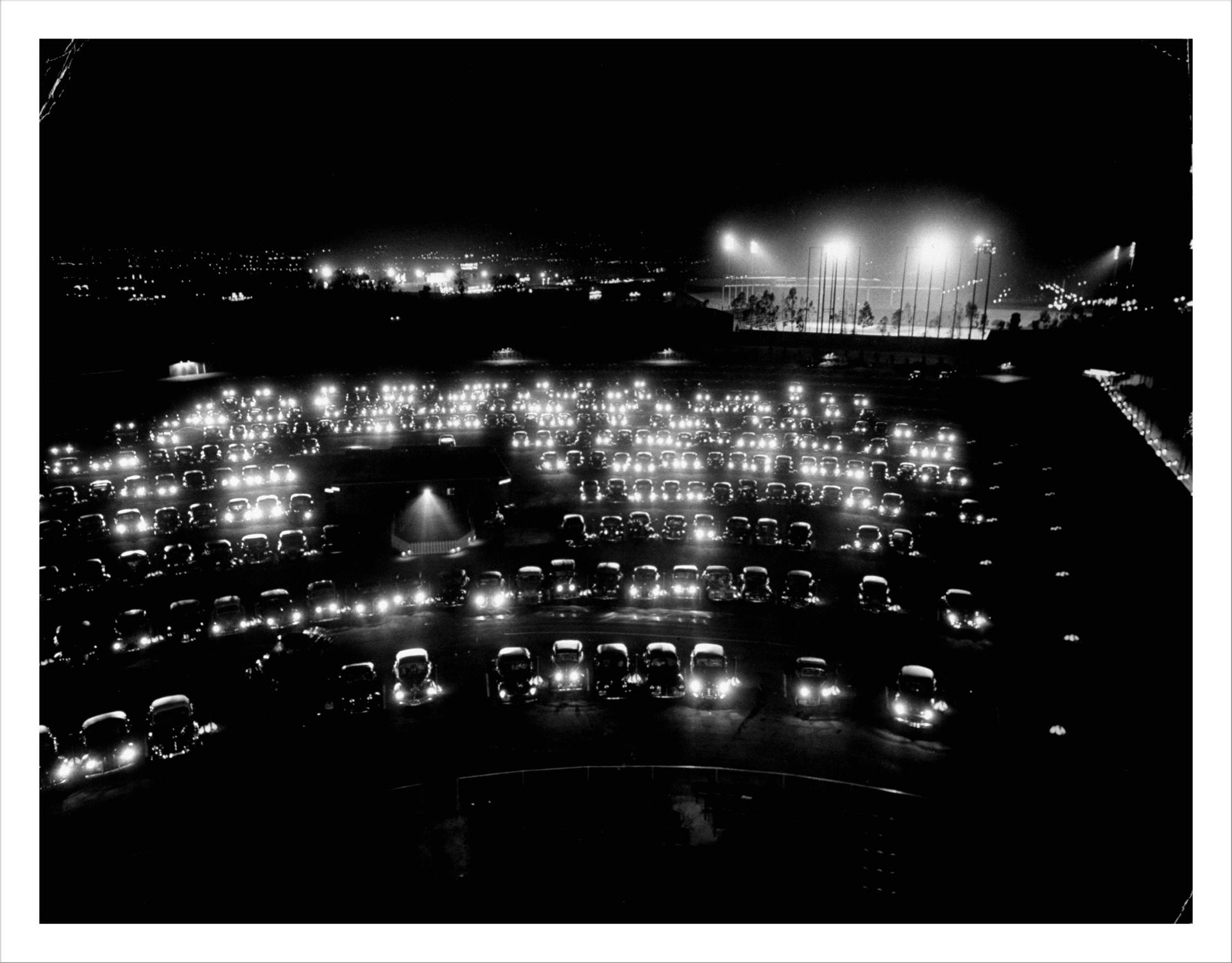 Loomis Dean | Cars, headlights on, in a drive-in theater on Gilmore ...