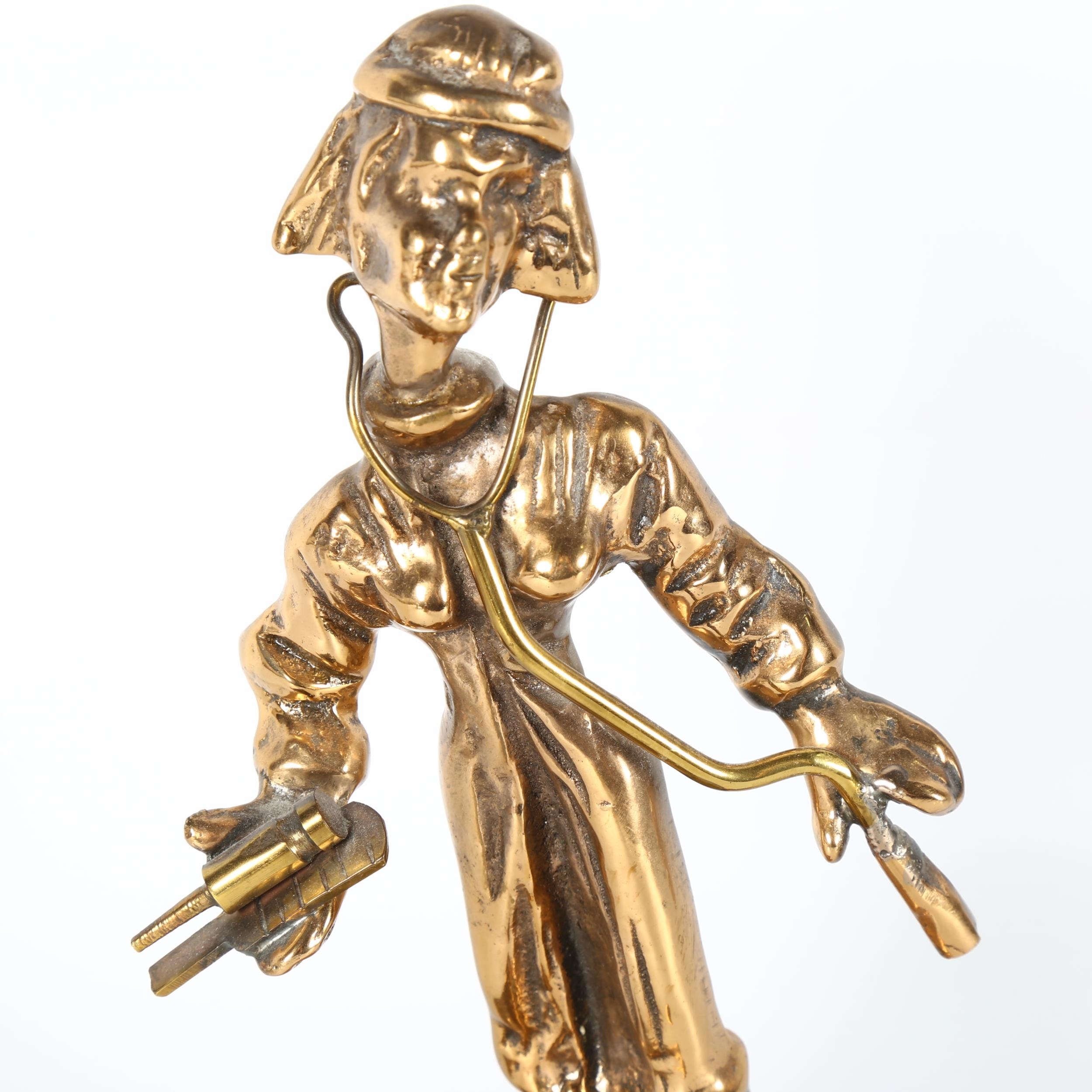 Yves Lohé | a gilded bronze sculpture of a doctor | MutualArt