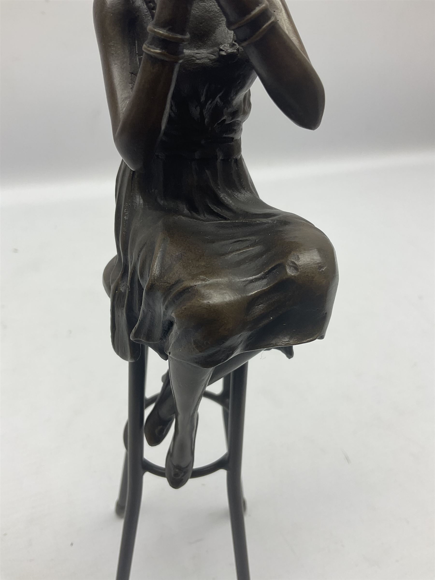 Demétre H. Chiparus | Lady seated on a stool applying lipstick | MutualArt
