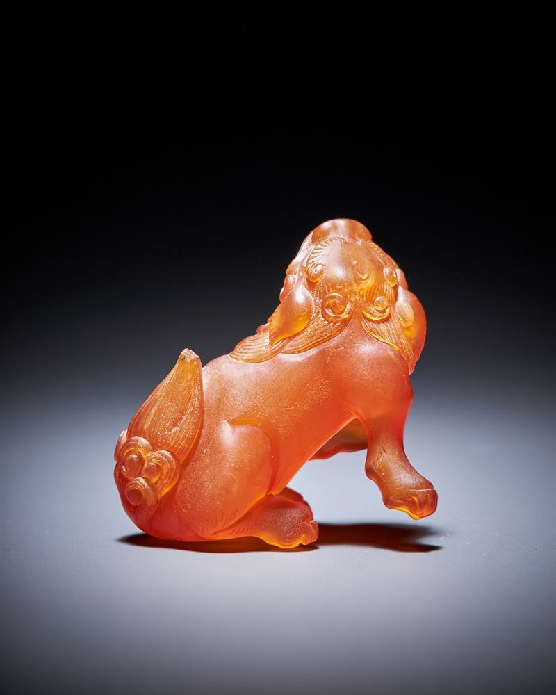 Chinese School | A Chinese amber carving of a lion | MutualArt