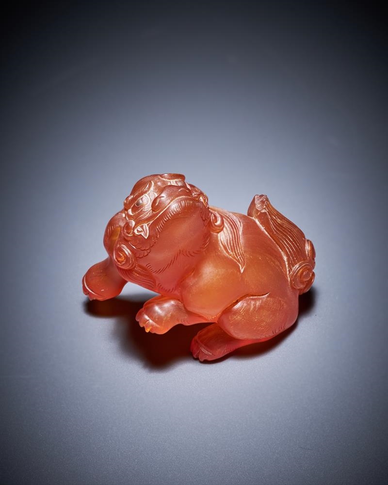 Chinese School | A Chinese amber carving of a lion | MutualArt