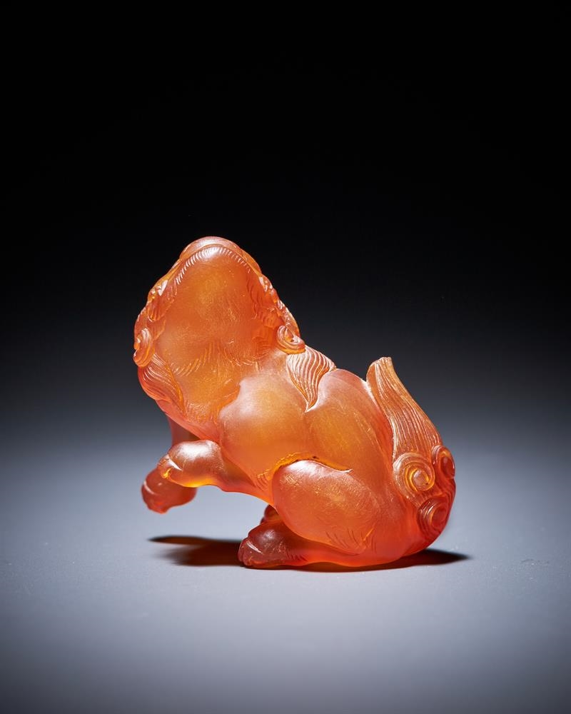 Chinese School | A Chinese amber carving of a lion | MutualArt