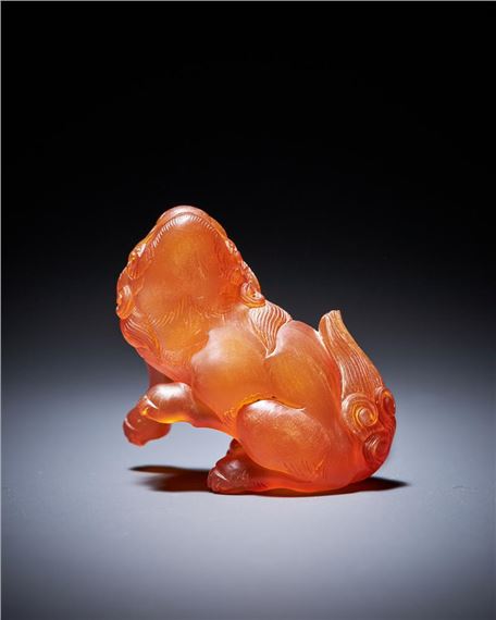 Chinese School | A Chinese amber carving of a lion | MutualArt