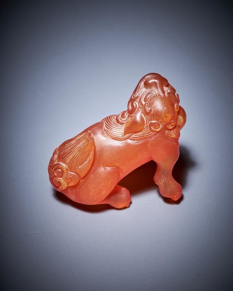 Chinese School | A Chinese amber carving of a lion | MutualArt