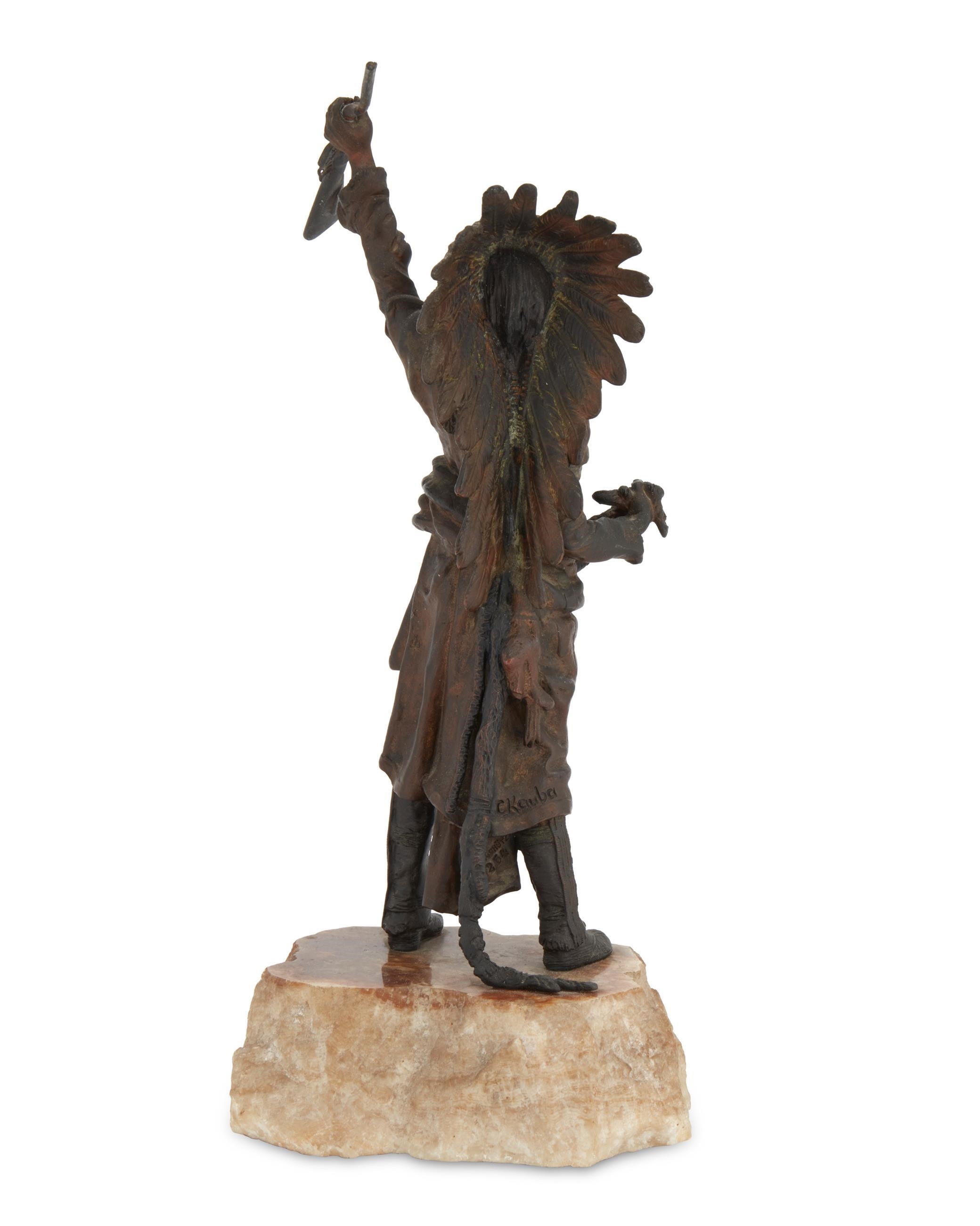 Carl Kauba | A Native American in headdress raising a rifle | MutualArt