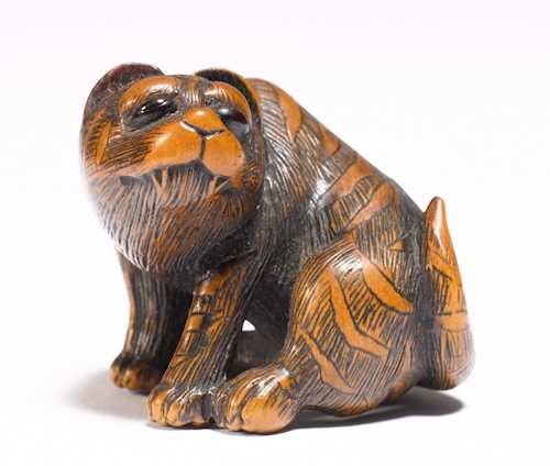Japanese School, 19th Century | A NETSUKE OF A SEATED TIGER. | MutualArt
