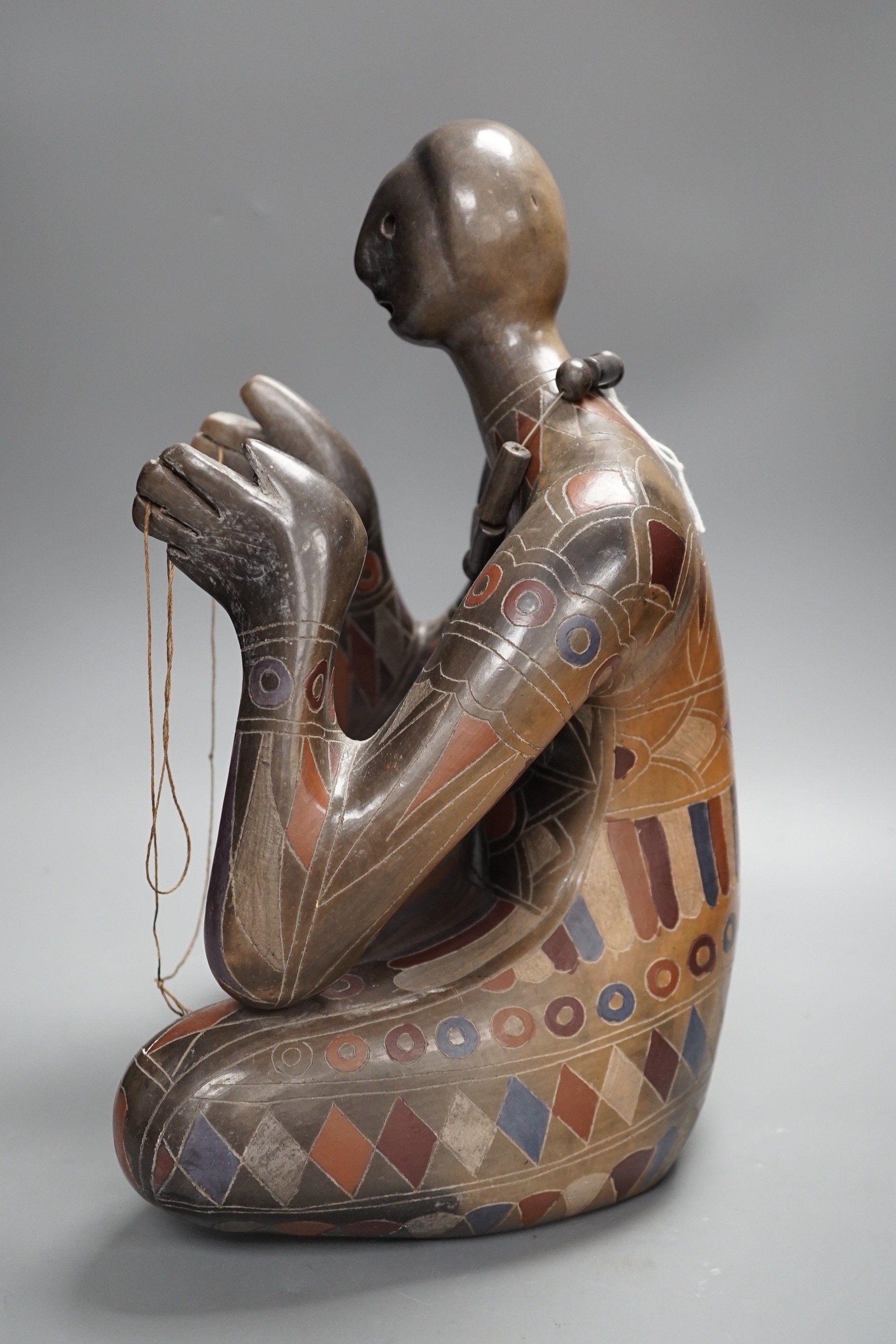 Manuel Felguérez | a terracotta abstract sculpture of a seated woman ...