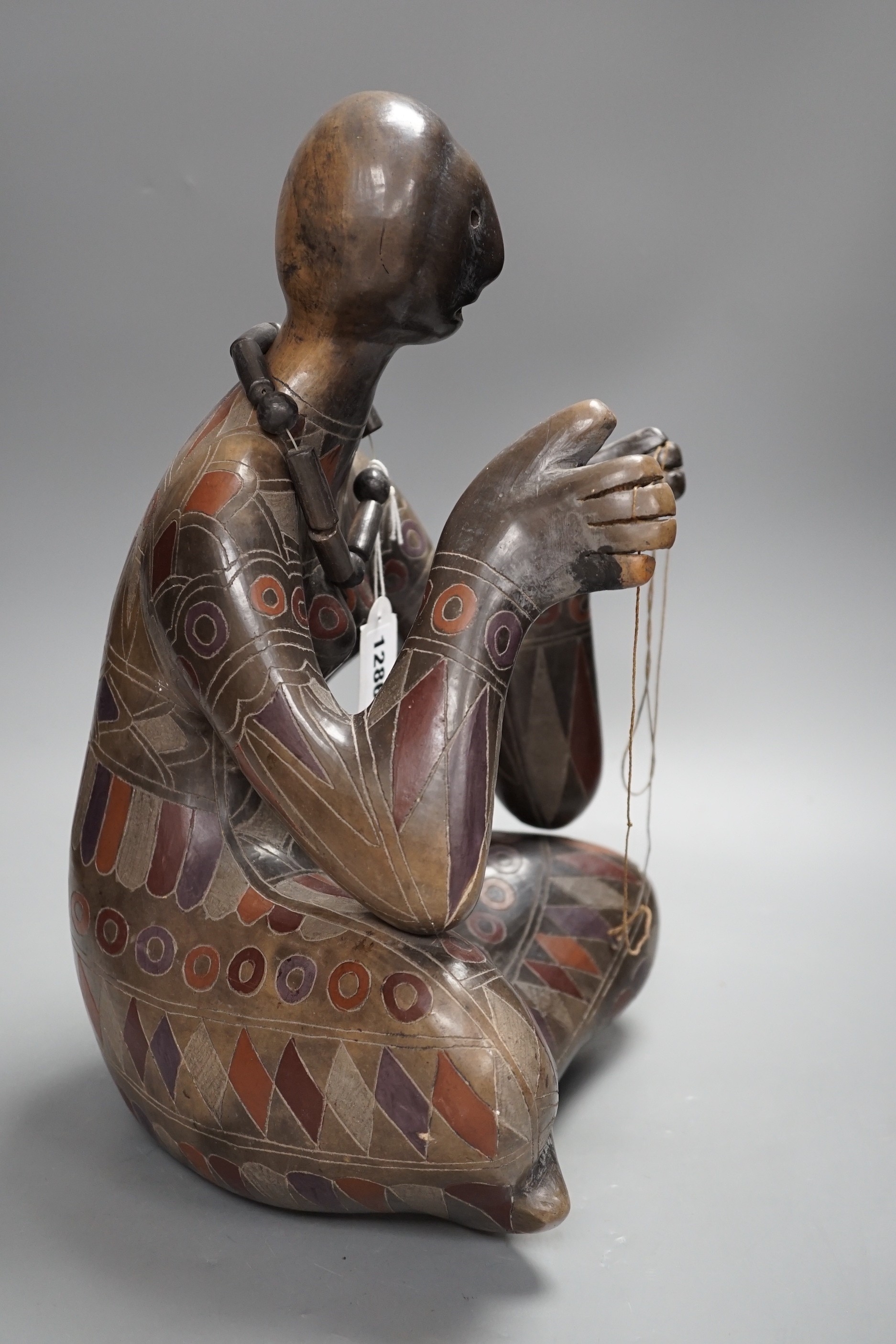 Manuel Felguérez | a terracotta abstract sculpture of a seated woman ...