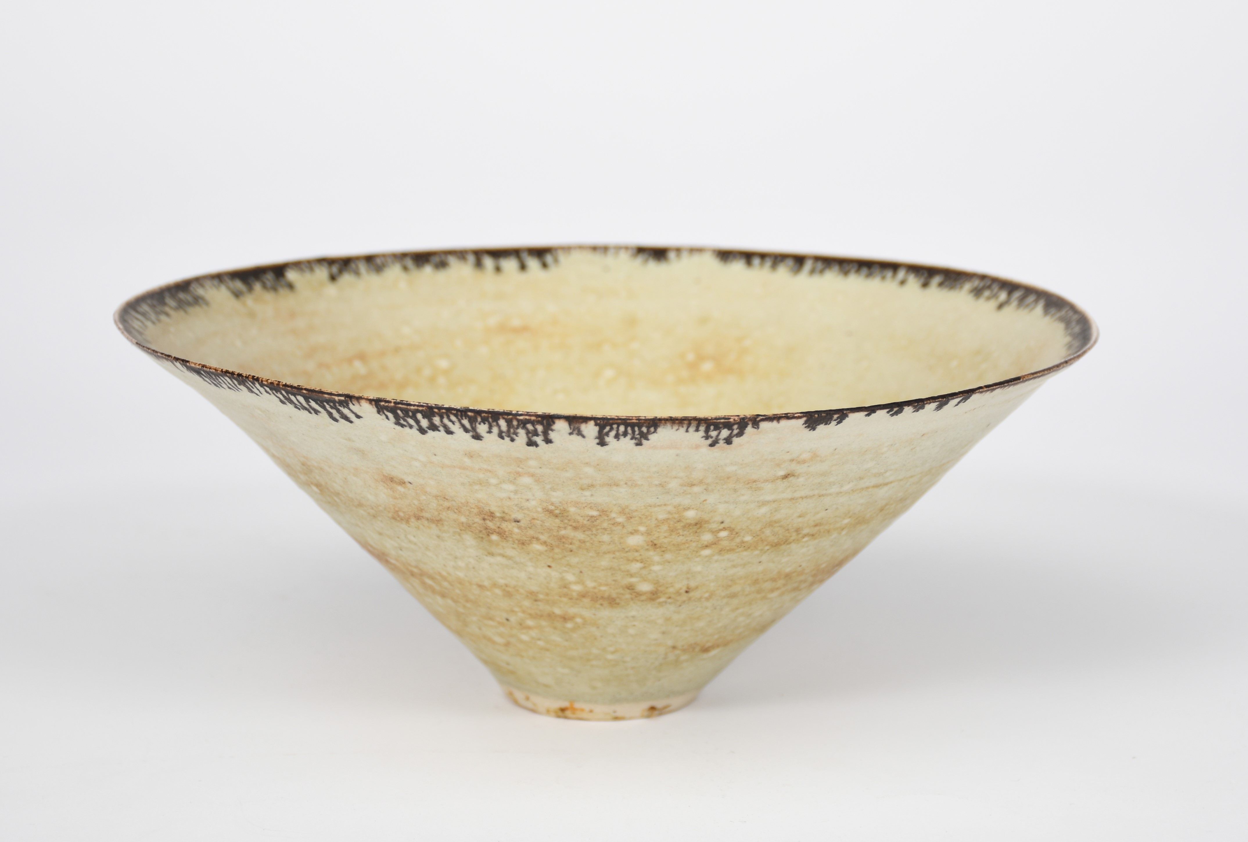 Lucie Rie | a porcelain bowl, flaring conical form, covered in a pitted ...