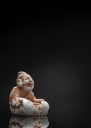Han Dynasty | A VERY RARE CALCIFIED JADE FIGURE OF A SEATED MAN | MutualArt