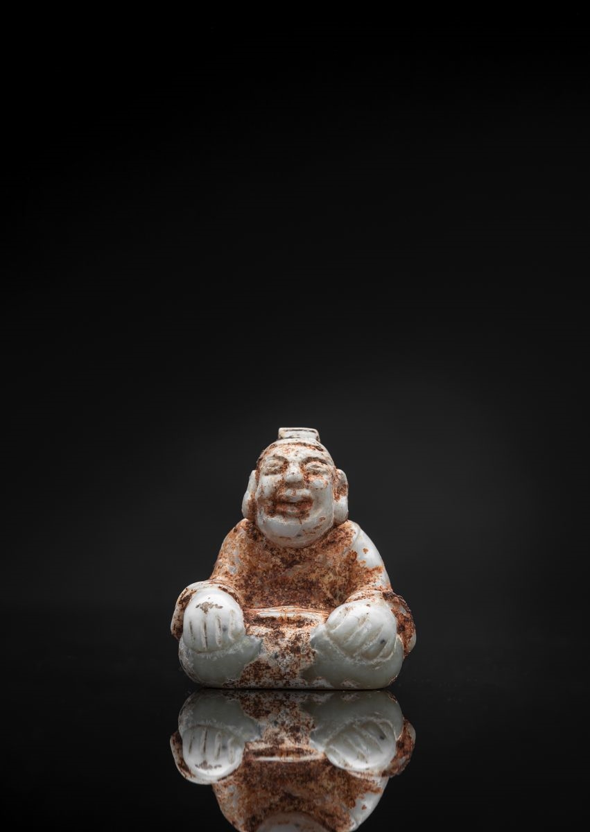 Han Dynasty | A VERY RARE CALCIFIED JADE FIGURE OF A SEATED MAN | MutualArt