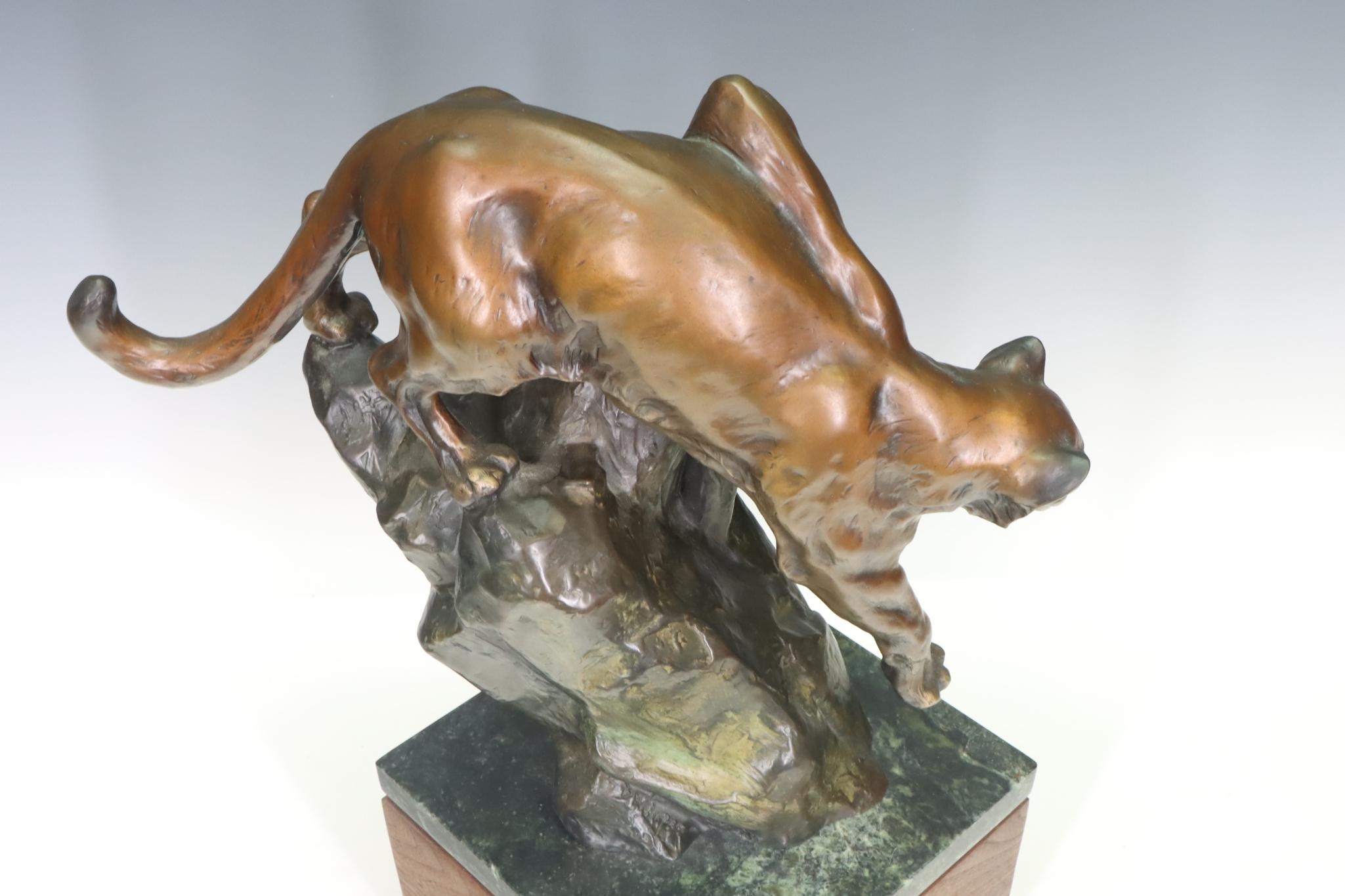 Dawn Weimer | depicting a mountain lion mounted to a marble slab on a ...