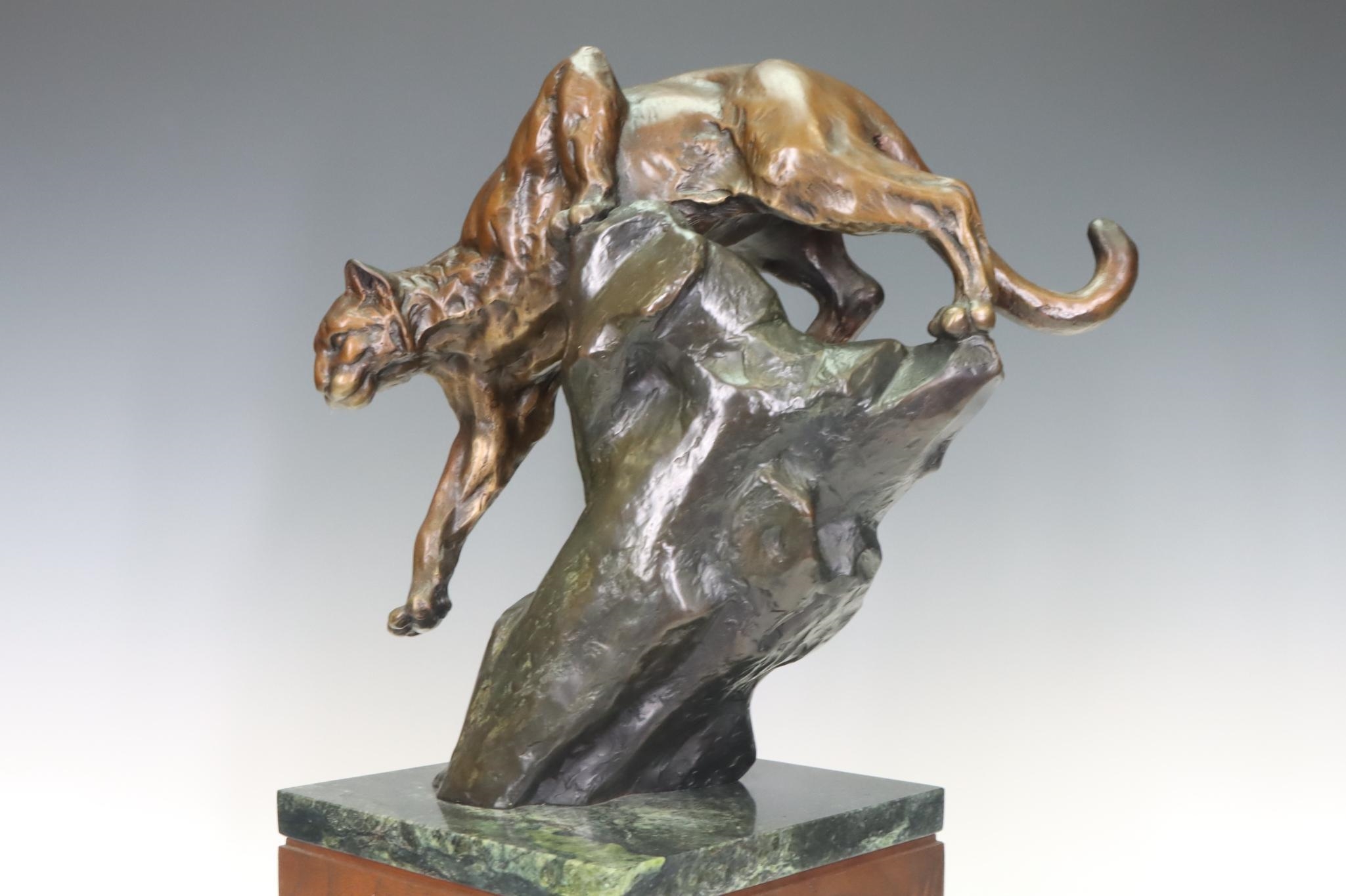 Dawn Weimer | depicting a mountain lion mounted to a marble slab on a ...