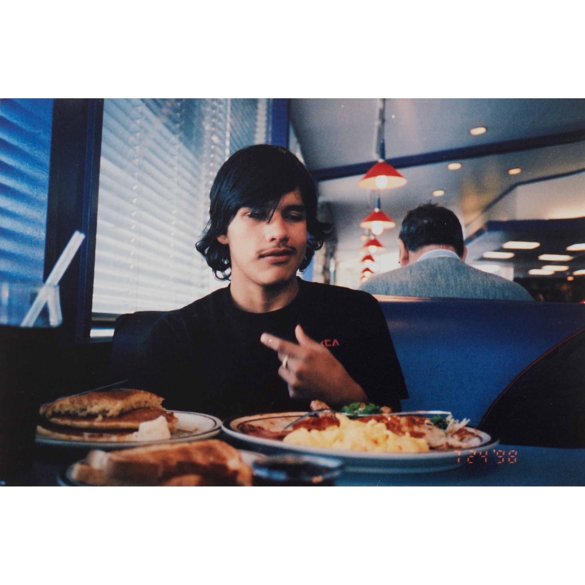 Larry Clark | JONATHAN VELASQUEZ IN A DINER - 1998 | MutualArt