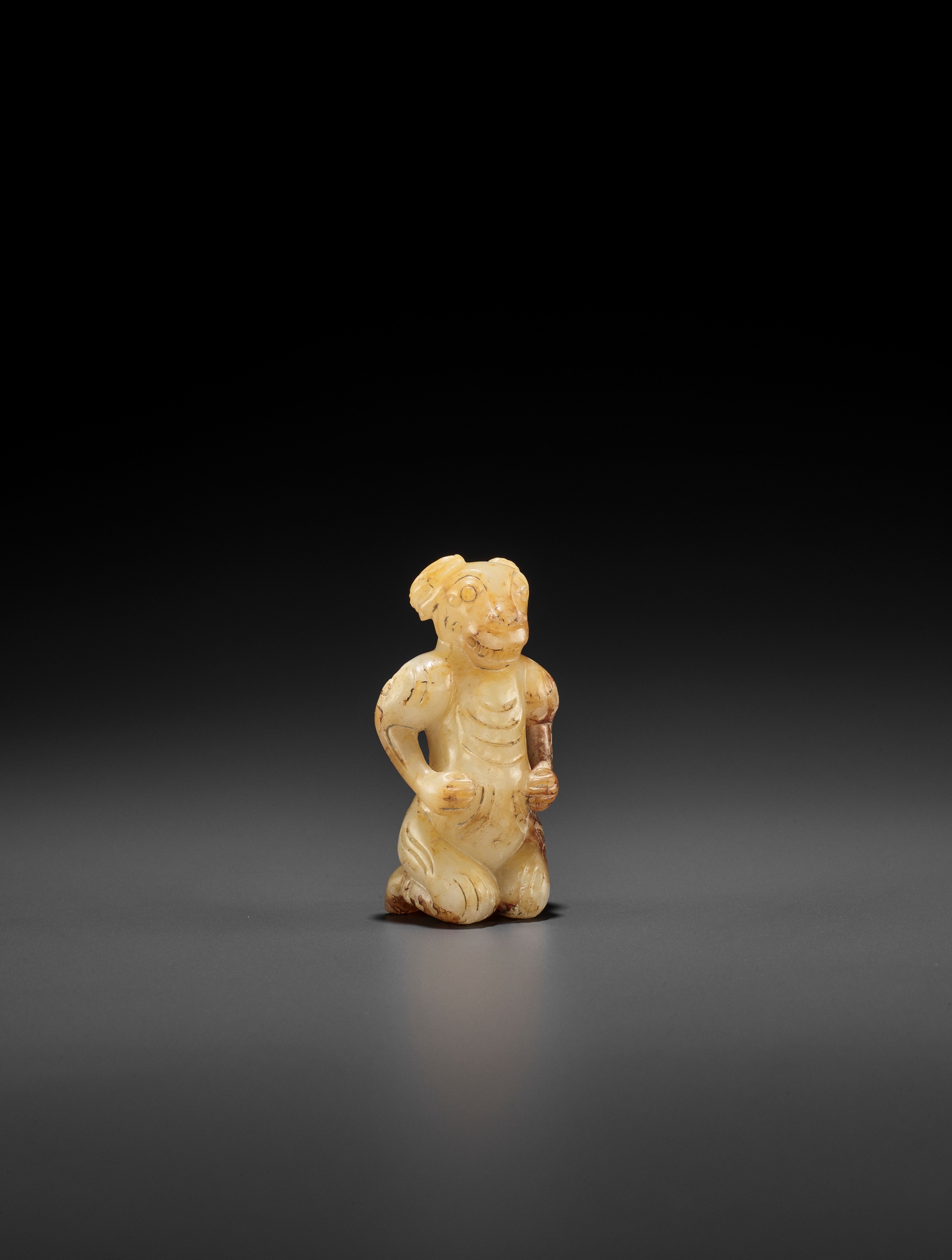 Han Dynasty | A YELLOW AND RUSSET JADE FIGURE WITH A RAM’S HEAD | MutualArt