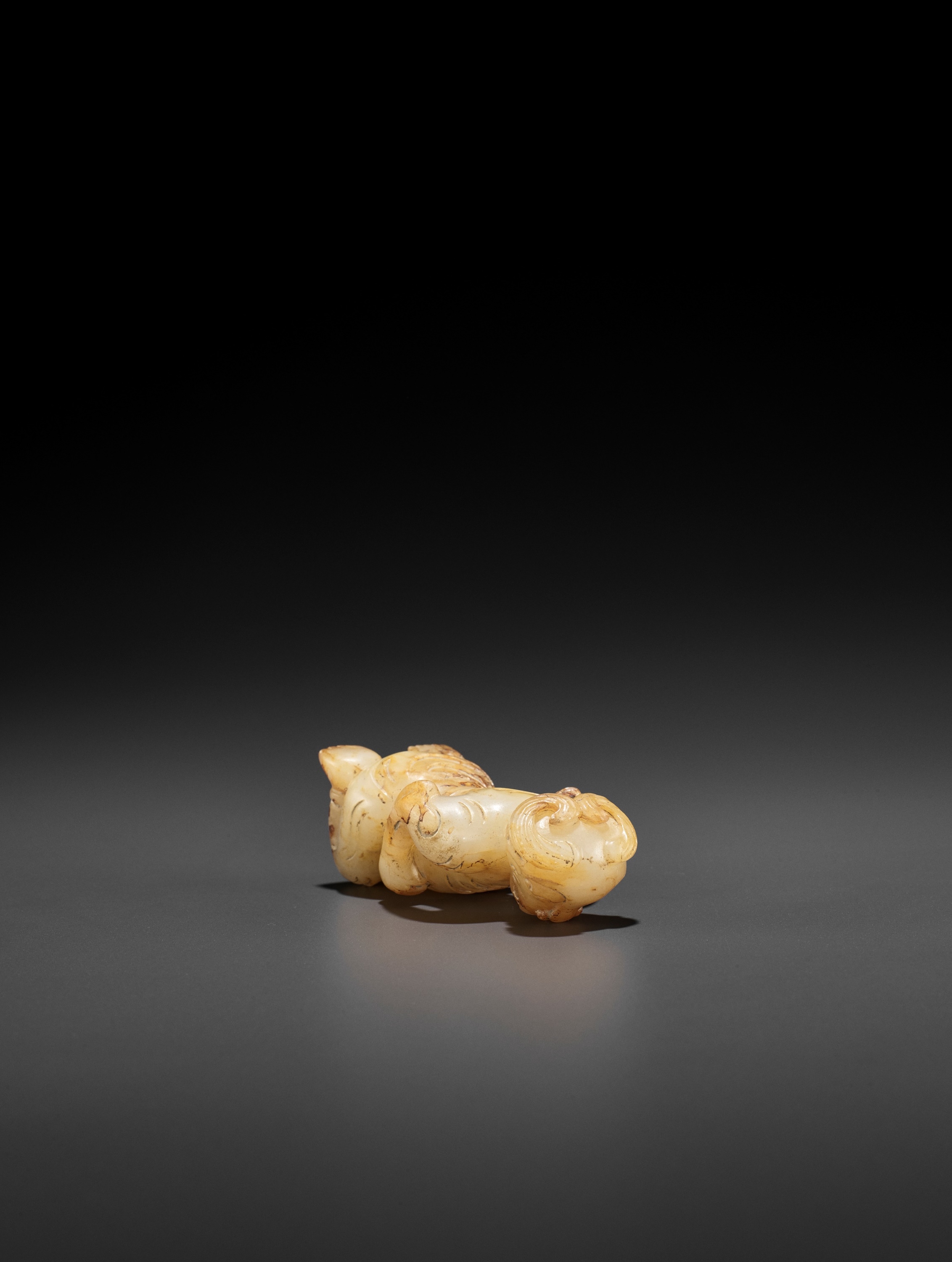 Han Dynasty | A YELLOW AND RUSSET JADE FIGURE WITH A RAM’S HEAD | MutualArt