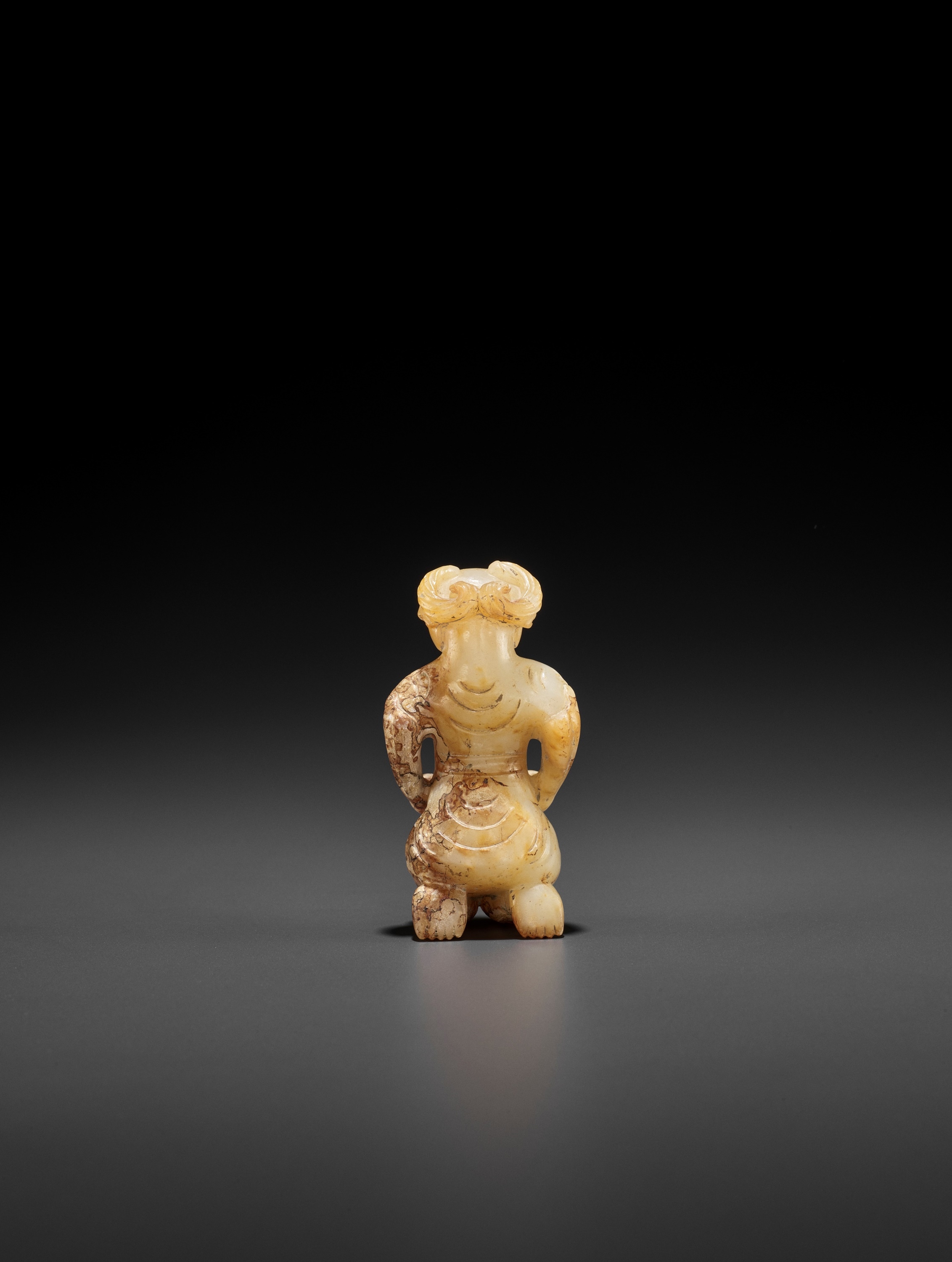 Han Dynasty | A YELLOW AND RUSSET JADE FIGURE WITH A RAM’S HEAD | MutualArt
