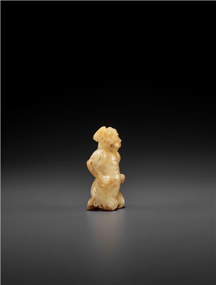 Han Dynasty | A YELLOW AND RUSSET JADE FIGURE WITH A RAM’S HEAD | MutualArt