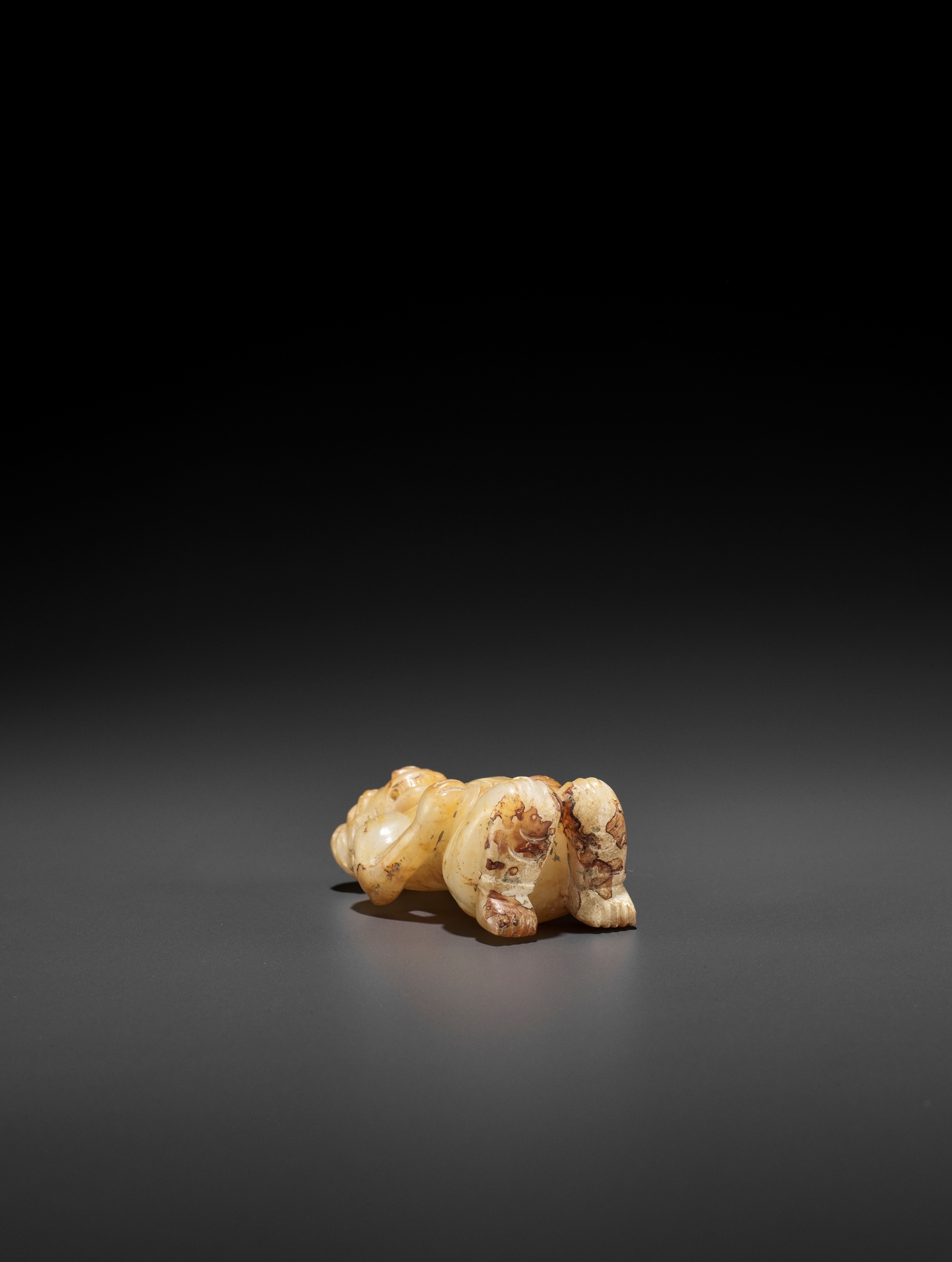 Han Dynasty | A YELLOW AND RUSSET JADE FIGURE WITH A RAM’S HEAD | MutualArt