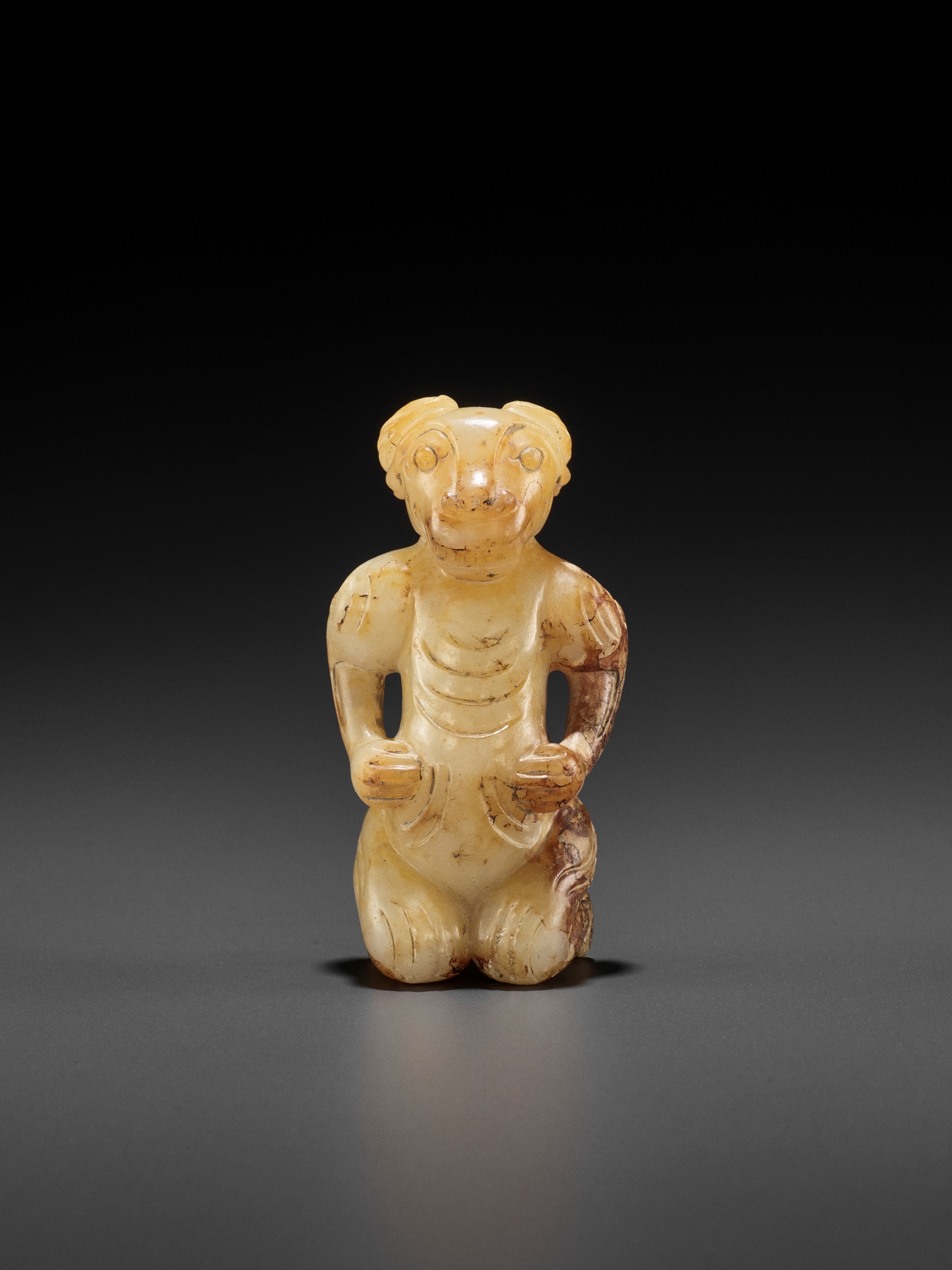Han Dynasty | A YELLOW AND RUSSET JADE FIGURE WITH A RAM’S HEAD | MutualArt