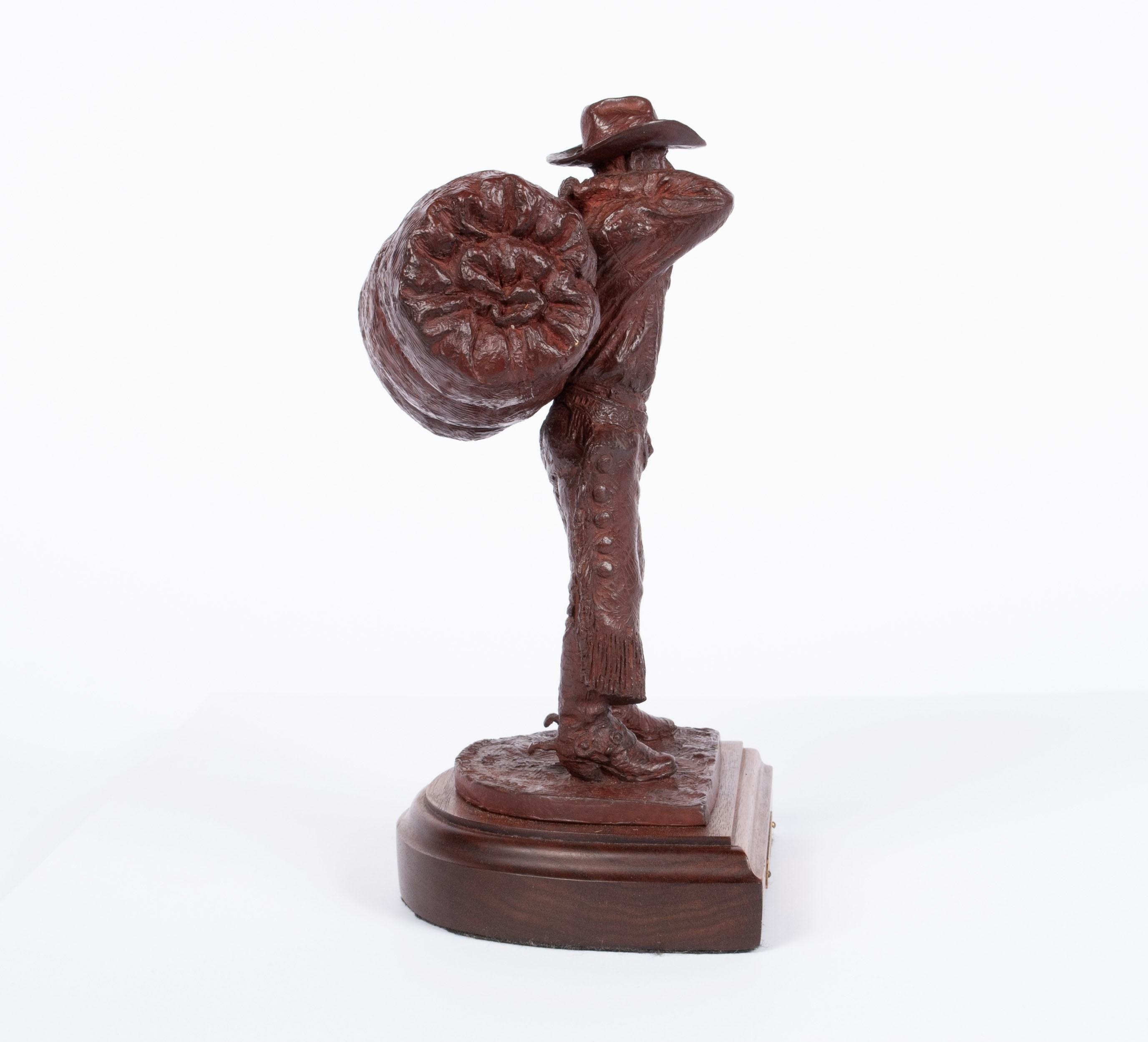 Harold Holden | Desktop bronze of a cowboy with sack roll over one ...