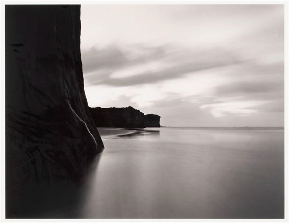 Chip Hooper | View of an undisturbed shoreline in the shadow of a cliff ...