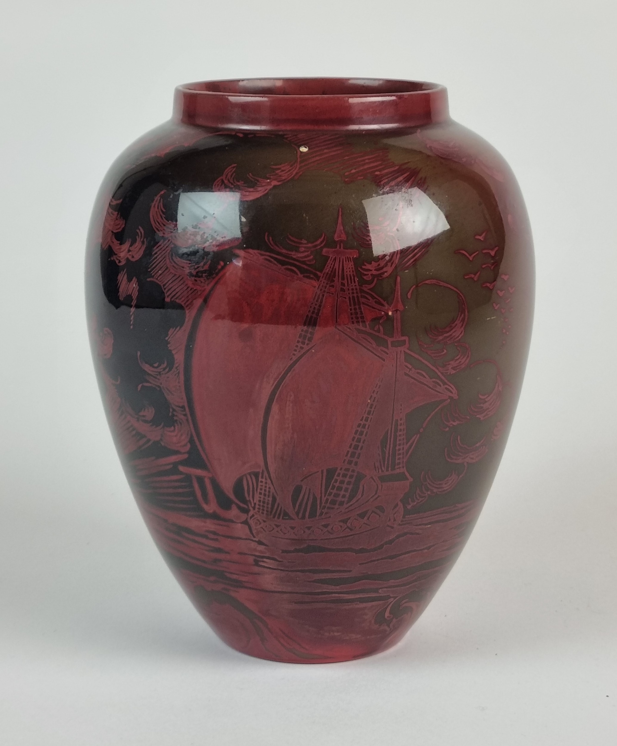 Bernard Moore | A red flambe vase decorated with two galleons in full ...