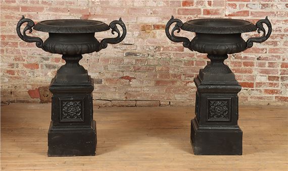 Unknown | A pair of painted black cast iron garden planters having ...