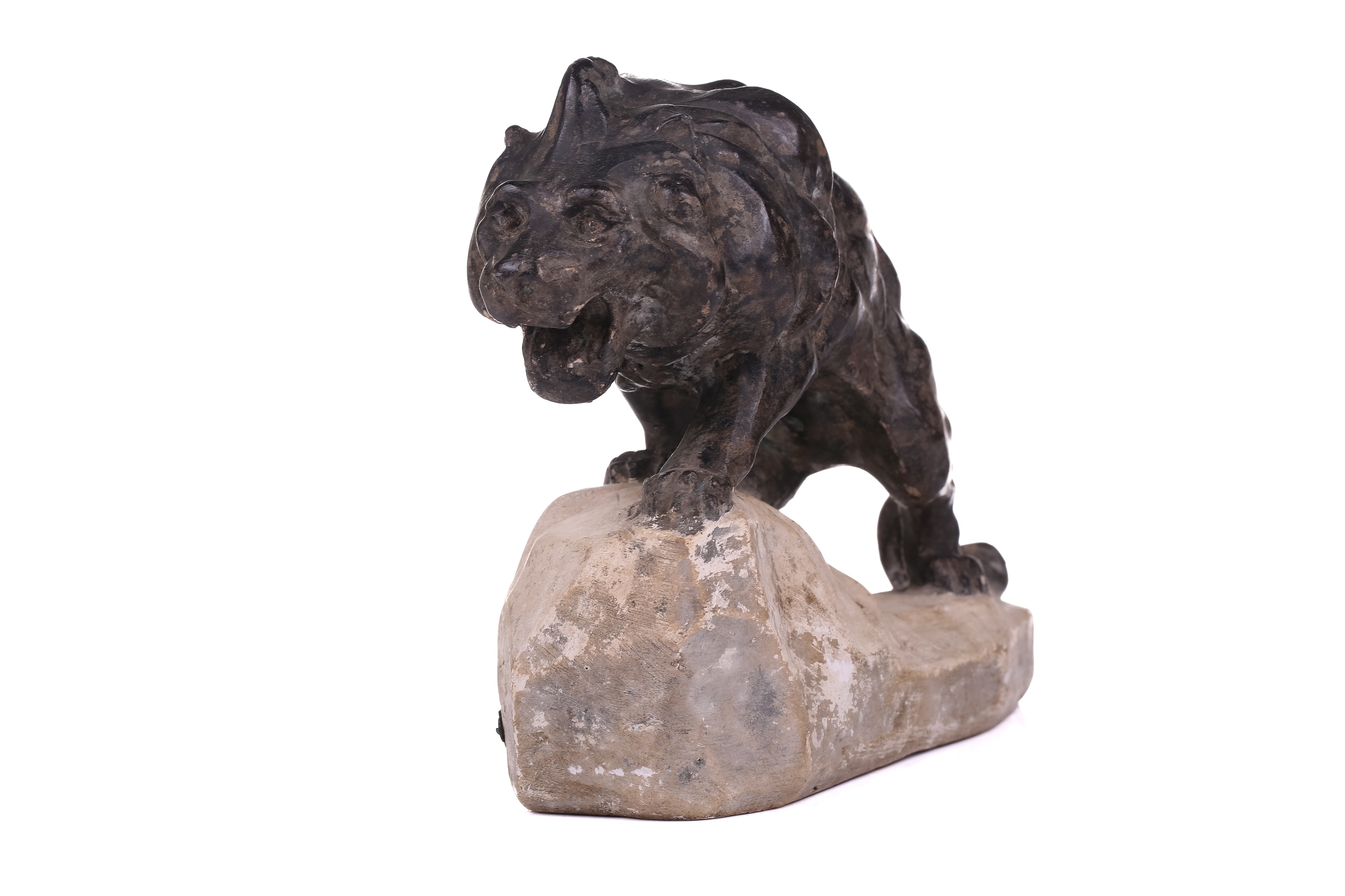 J. Colombini | A patinated composite sculpture of a lion on a rock ...