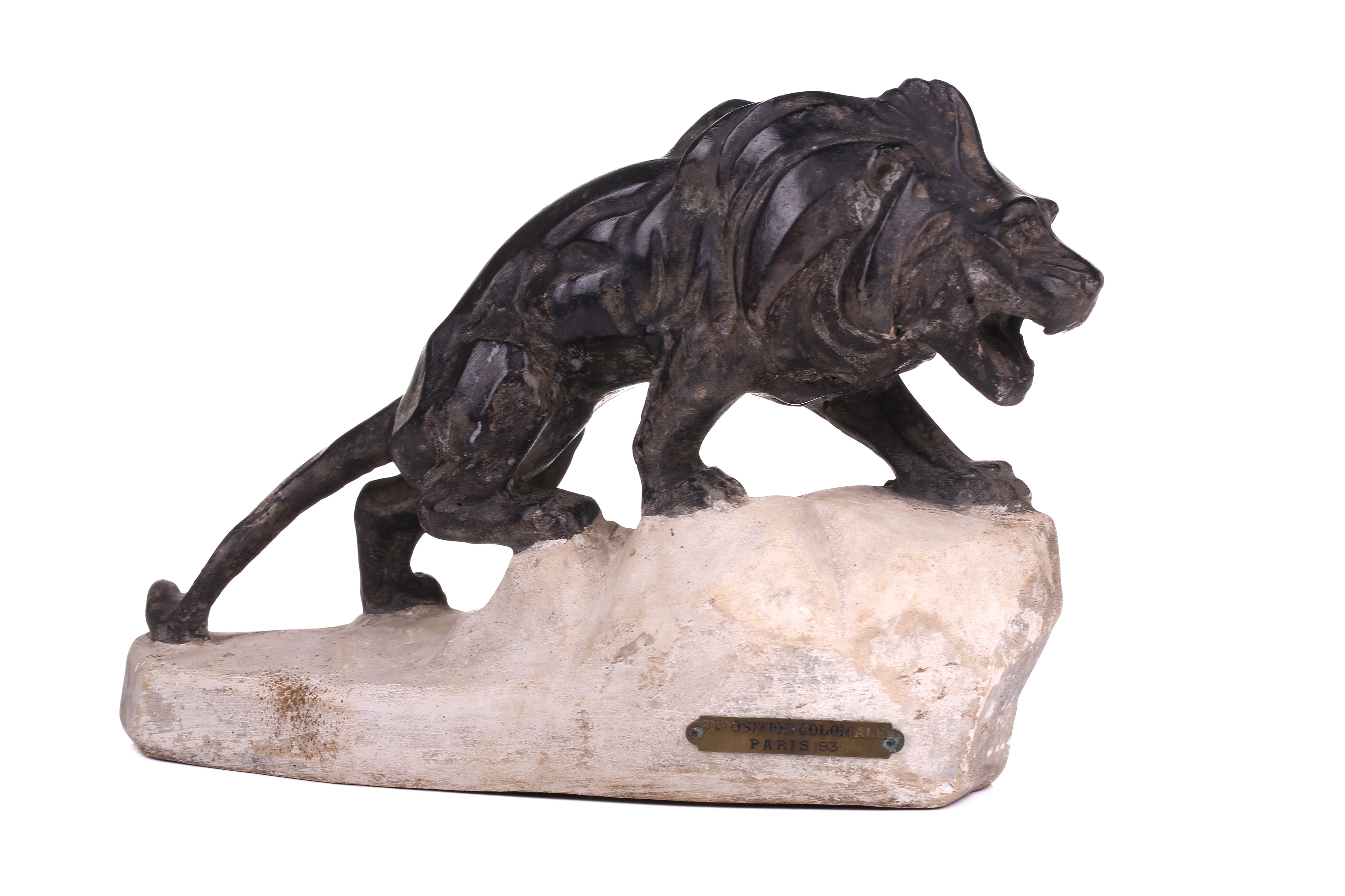 J. Colombini | A patinated composite sculpture of a lion on a rock ...