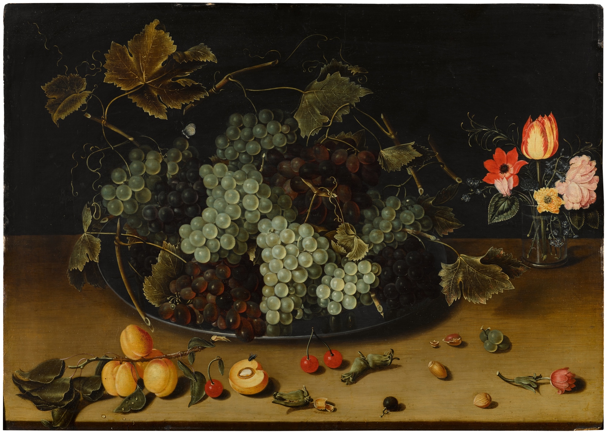 Isaac Soreau | Still life with grapes on a pewter dish, a vase of ...