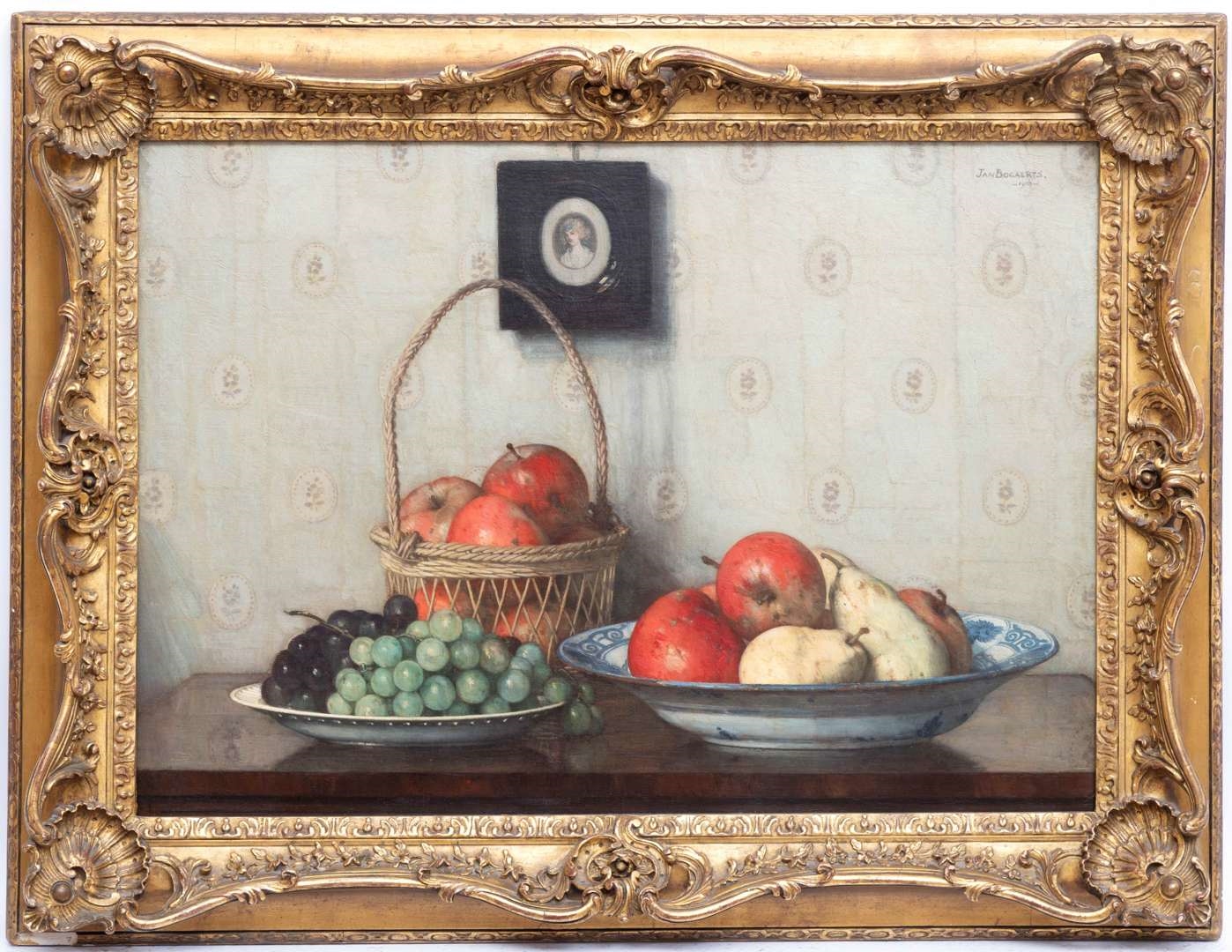 Jan Bogaerts | A still life with fruit in plates and a wicker basket on ...