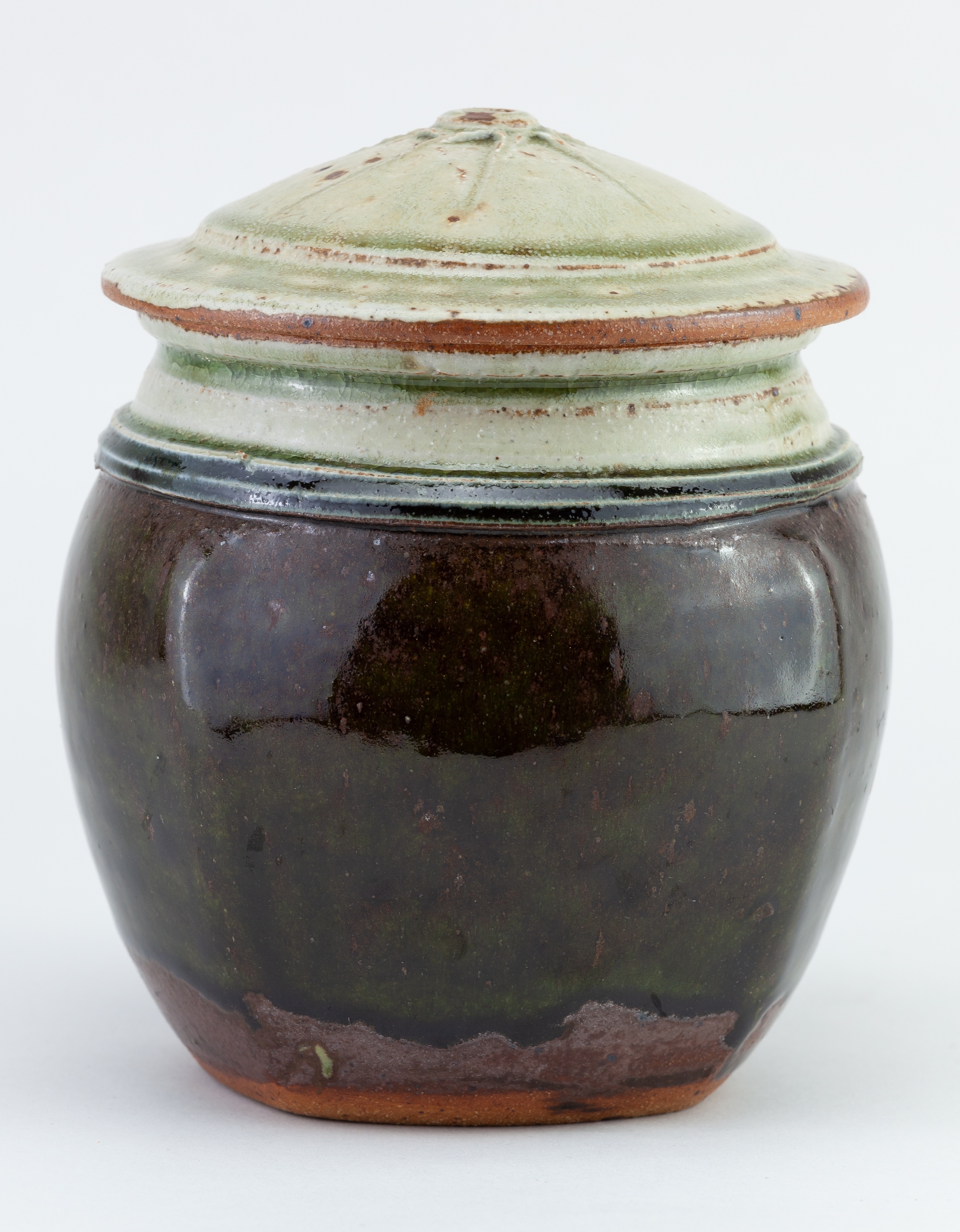 Richard Batterham | a beaten stoneware jar and cover covered in iron ...
