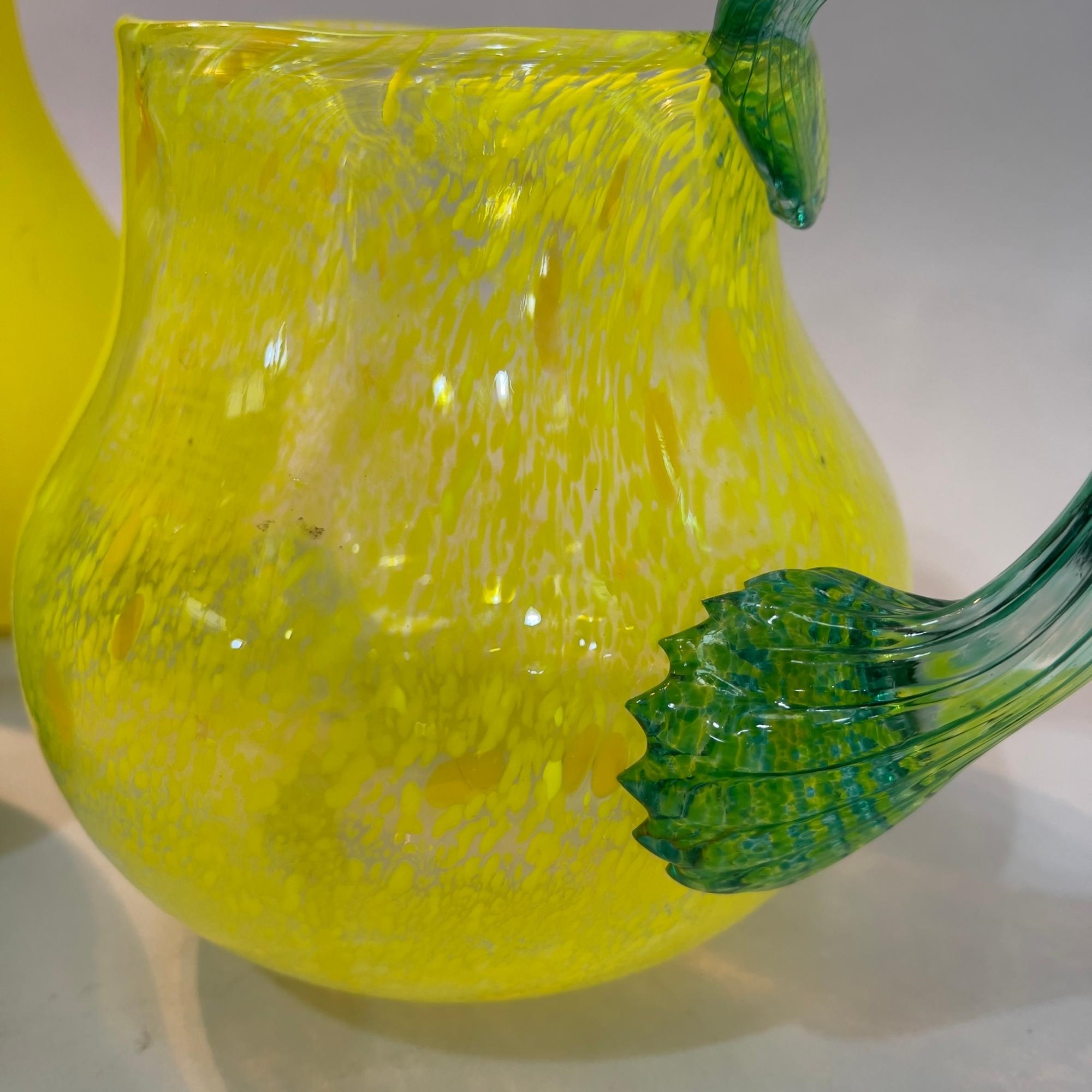 Gunnel Sahlin | a green glass bottle shaped vase and another in yellow ...