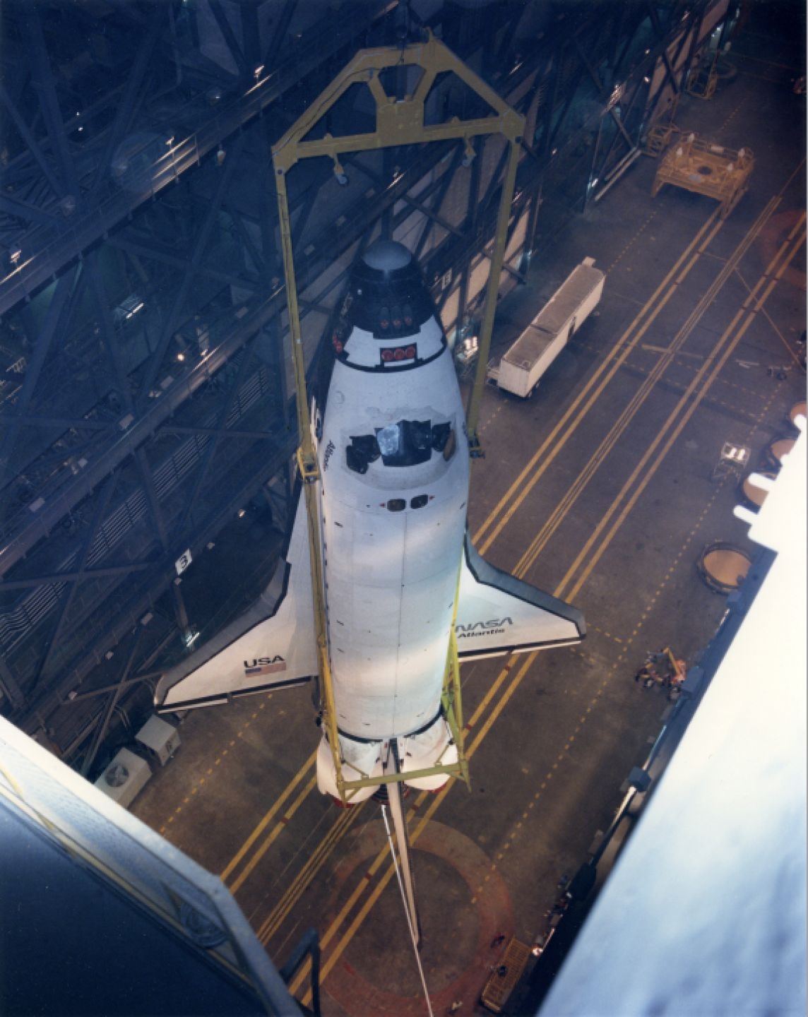 NASA | Space shuttle Atlantis is placed on its external tank using a lifting crane in ...