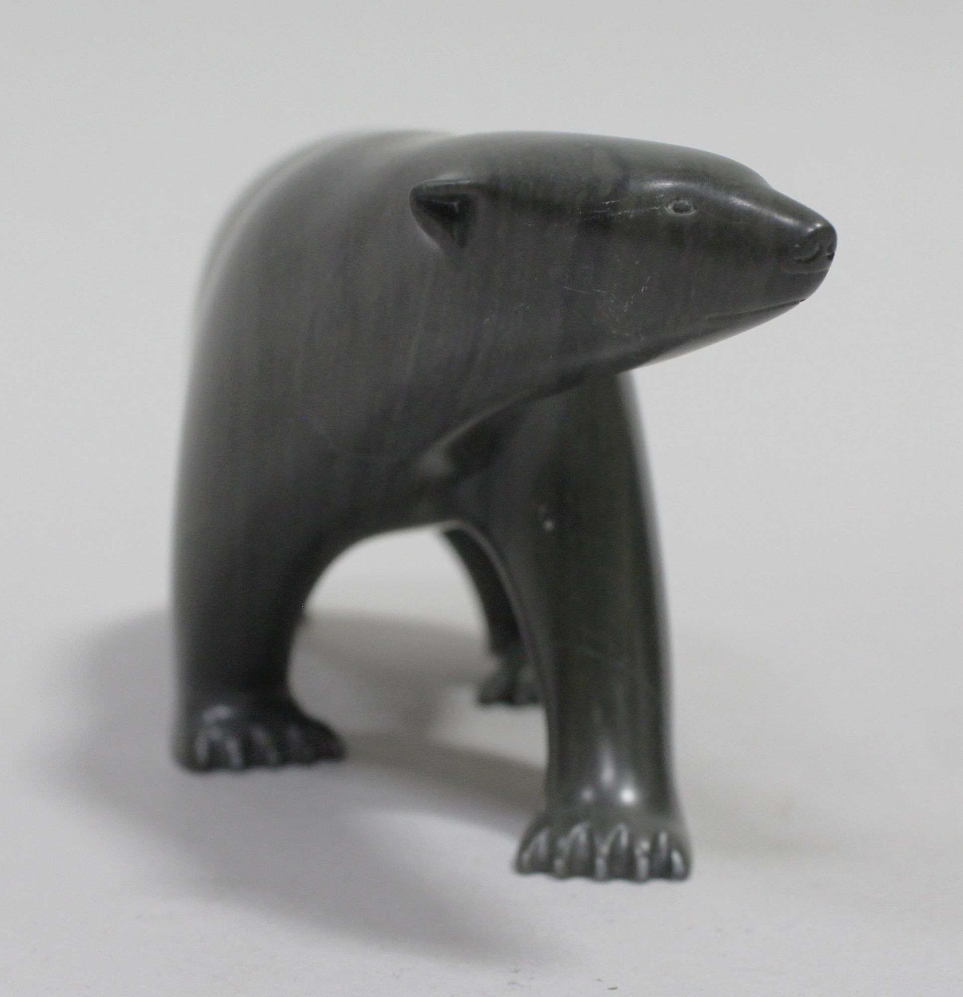 Lucassie Ippak | Grey-green stone carving of a Polar Bear, signed in ...