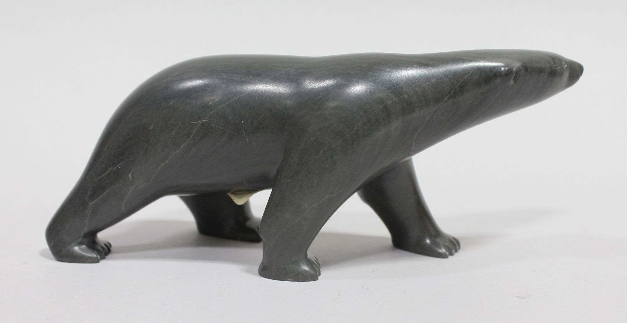 Lucassie Ippak | Grey-green stone carving of a Polar Bear, signed in ...