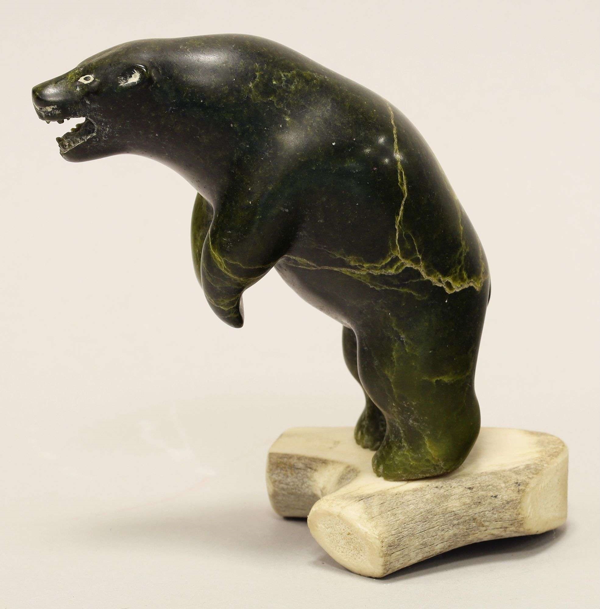 David Analok | A dark green stone carving of a Standing Bear on an ...